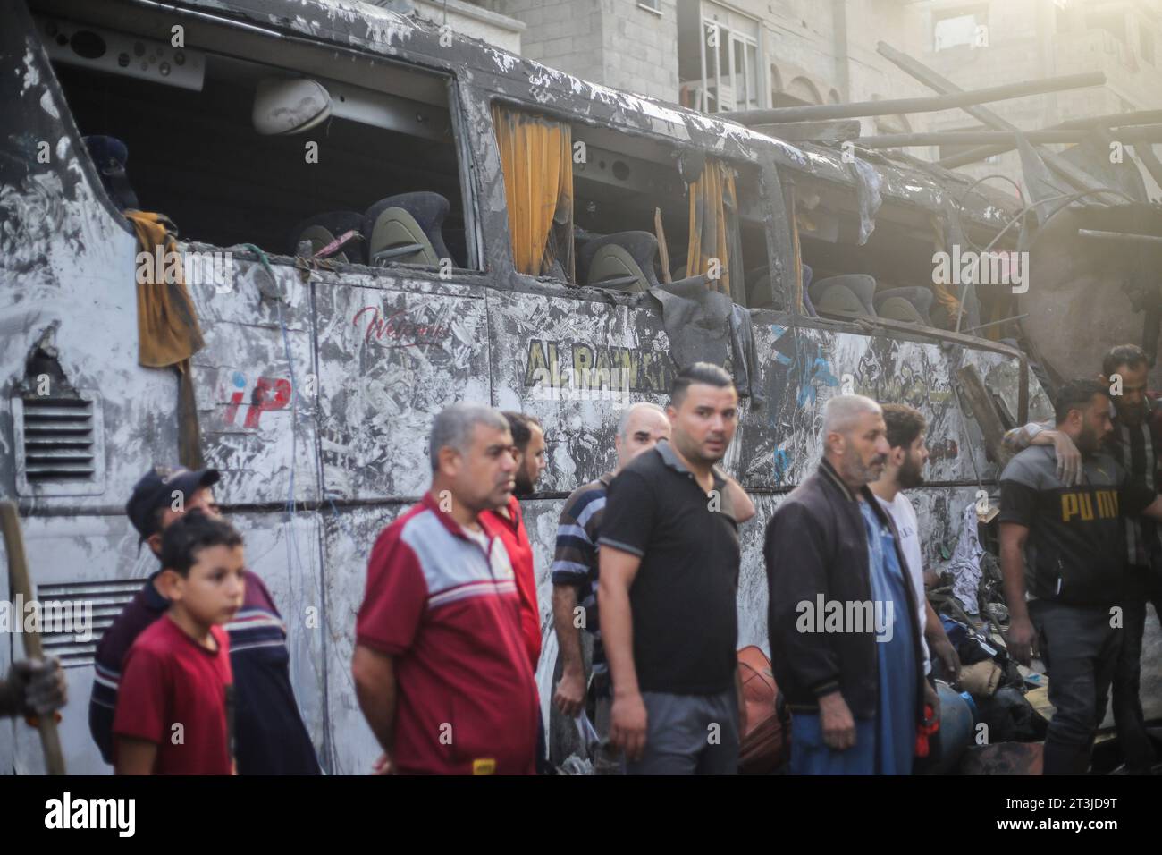 Gaza, Palestine. 25th Oct, 2023. A damaged bus is seen as Palestinians ...