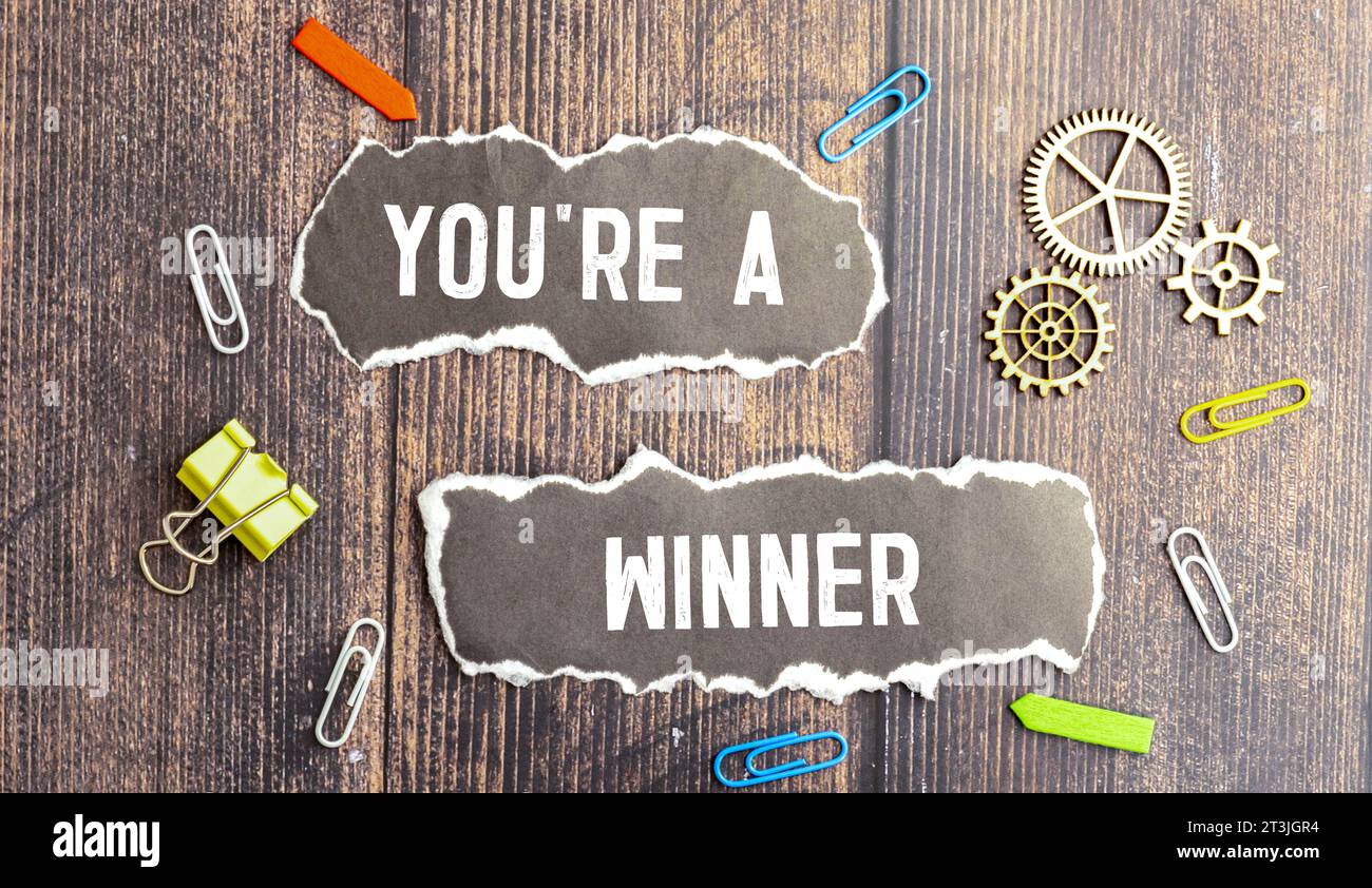 white paper with text You Re A Winner on a yellow background with ...