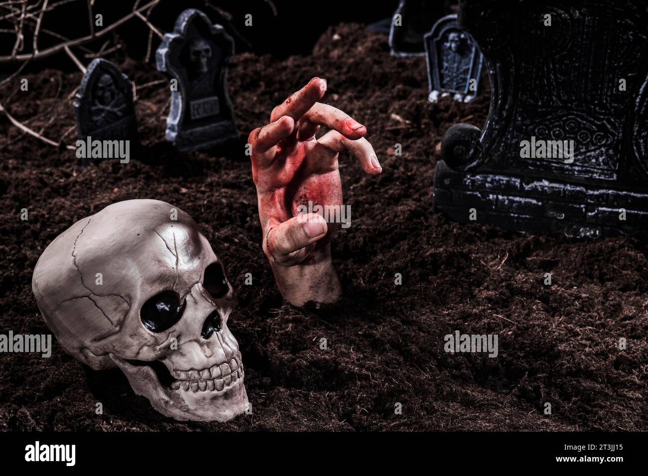 Alive hand with blood protruding from grave Stock Photo - Alamy