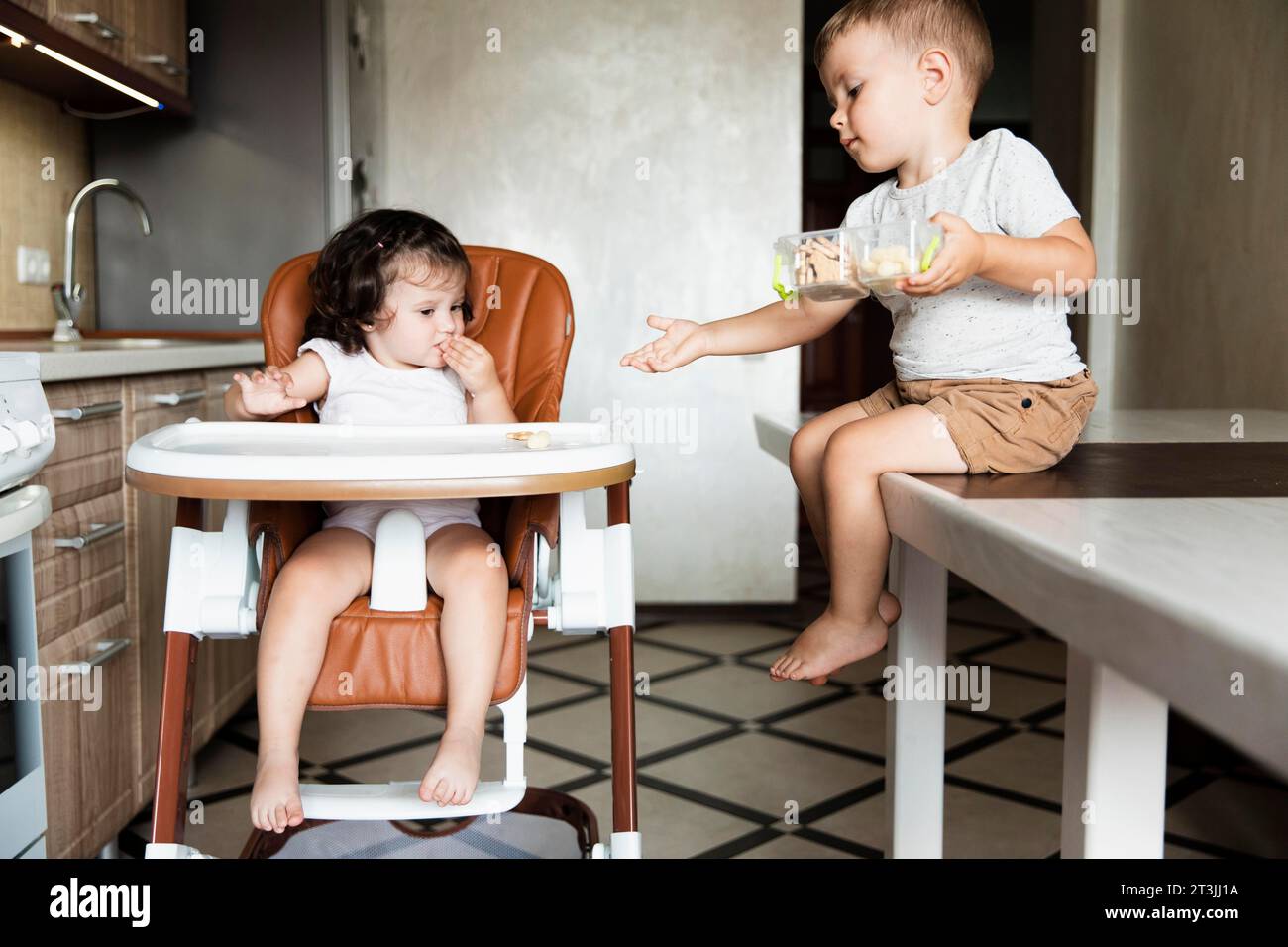 Adorable young siblings kitchen Stock Photo - Alamy