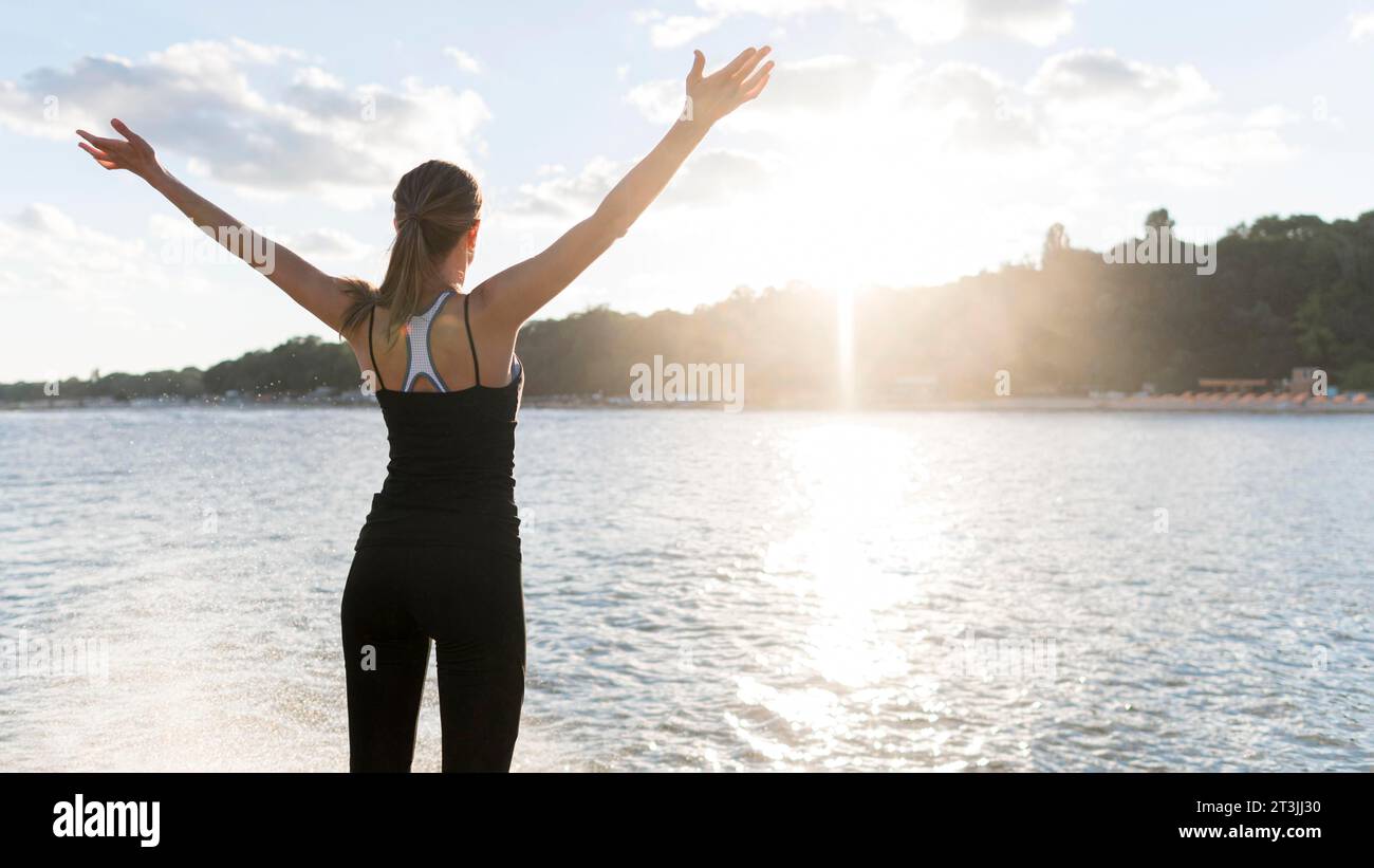 Back view woman enjoying sun light Stock Photo - Alamy