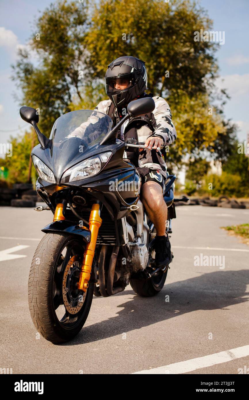 Biker motorbike waiting cross road Stock Photo - Alamy