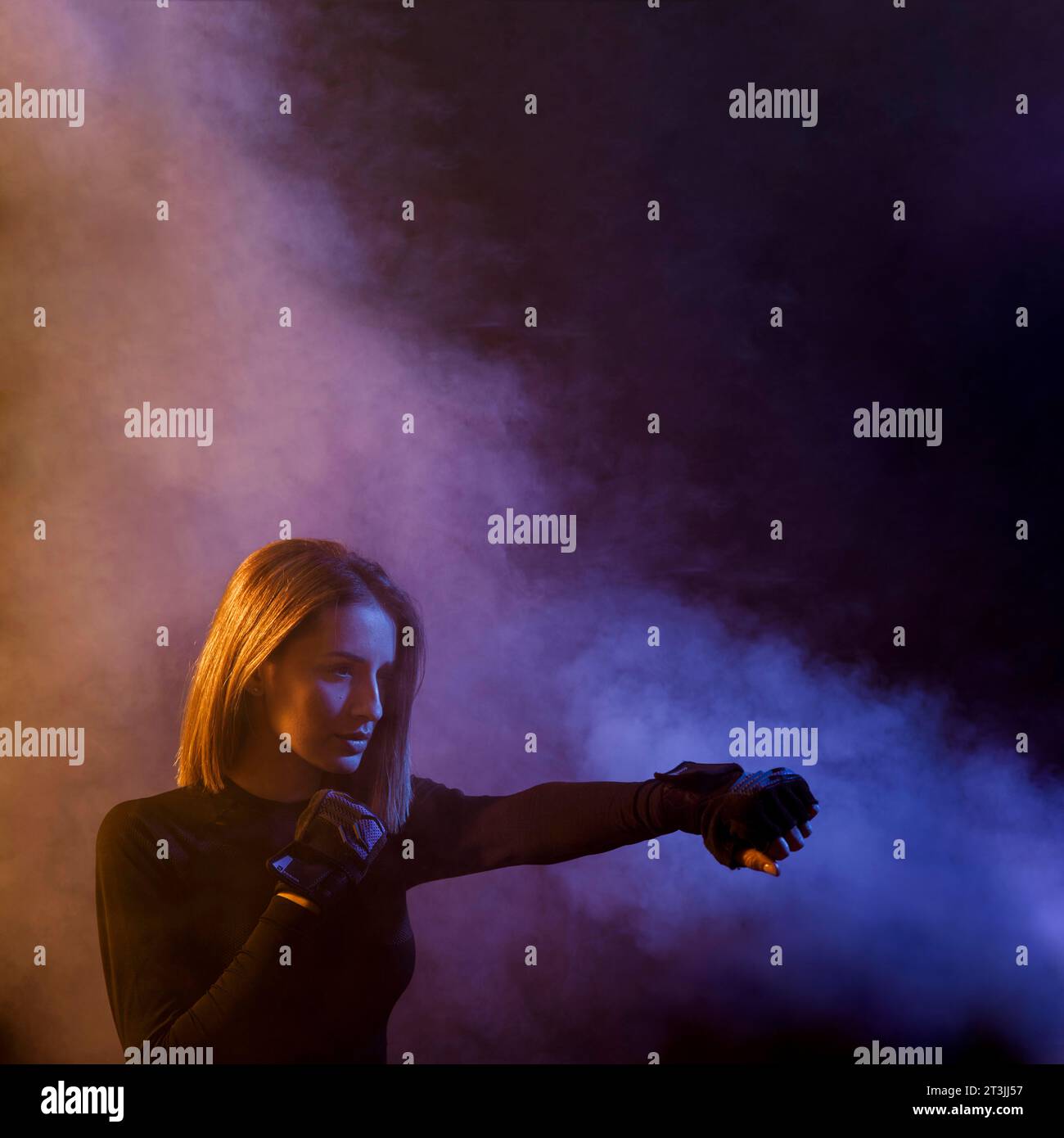 Boxing woman posing smoke Stock Photo - Alamy