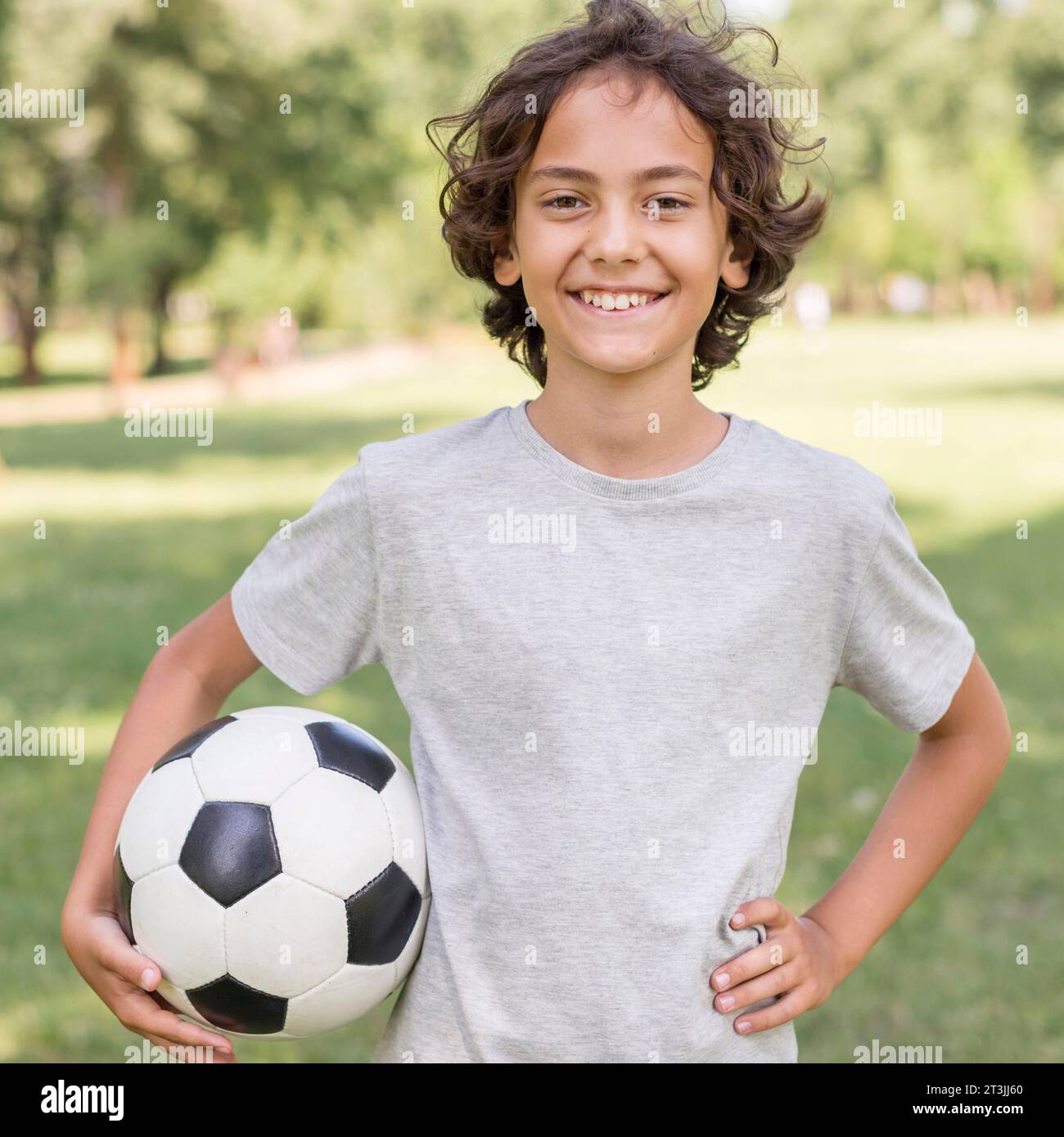 Boy playing with football ball Stock Photo - Alamy