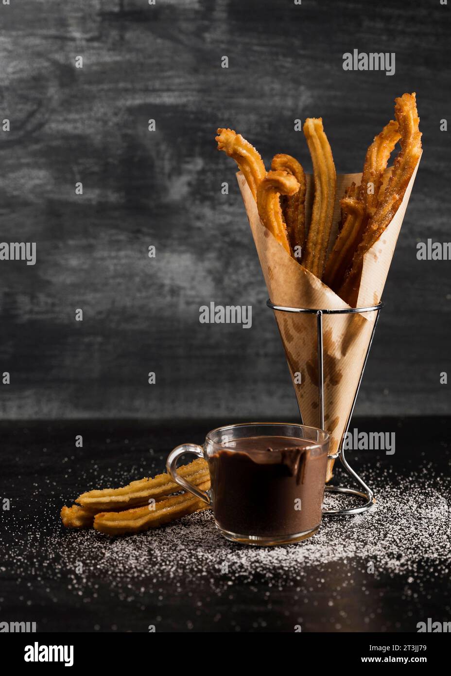 Churros ina glass chocolate long view Stock Photo - Alamy