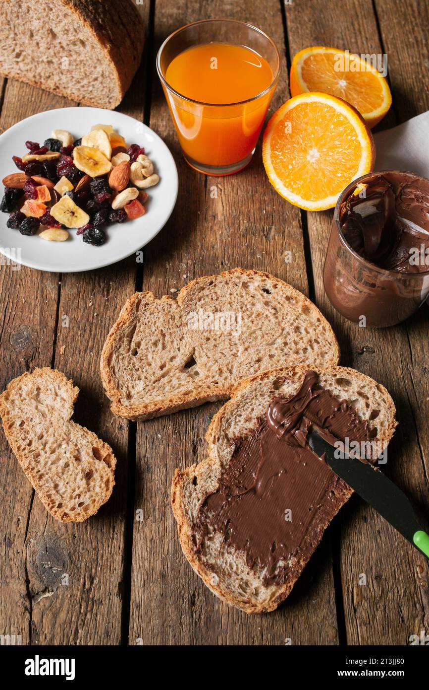 Chocolate spread bread slice with orange juice Stock Photo - Alamy