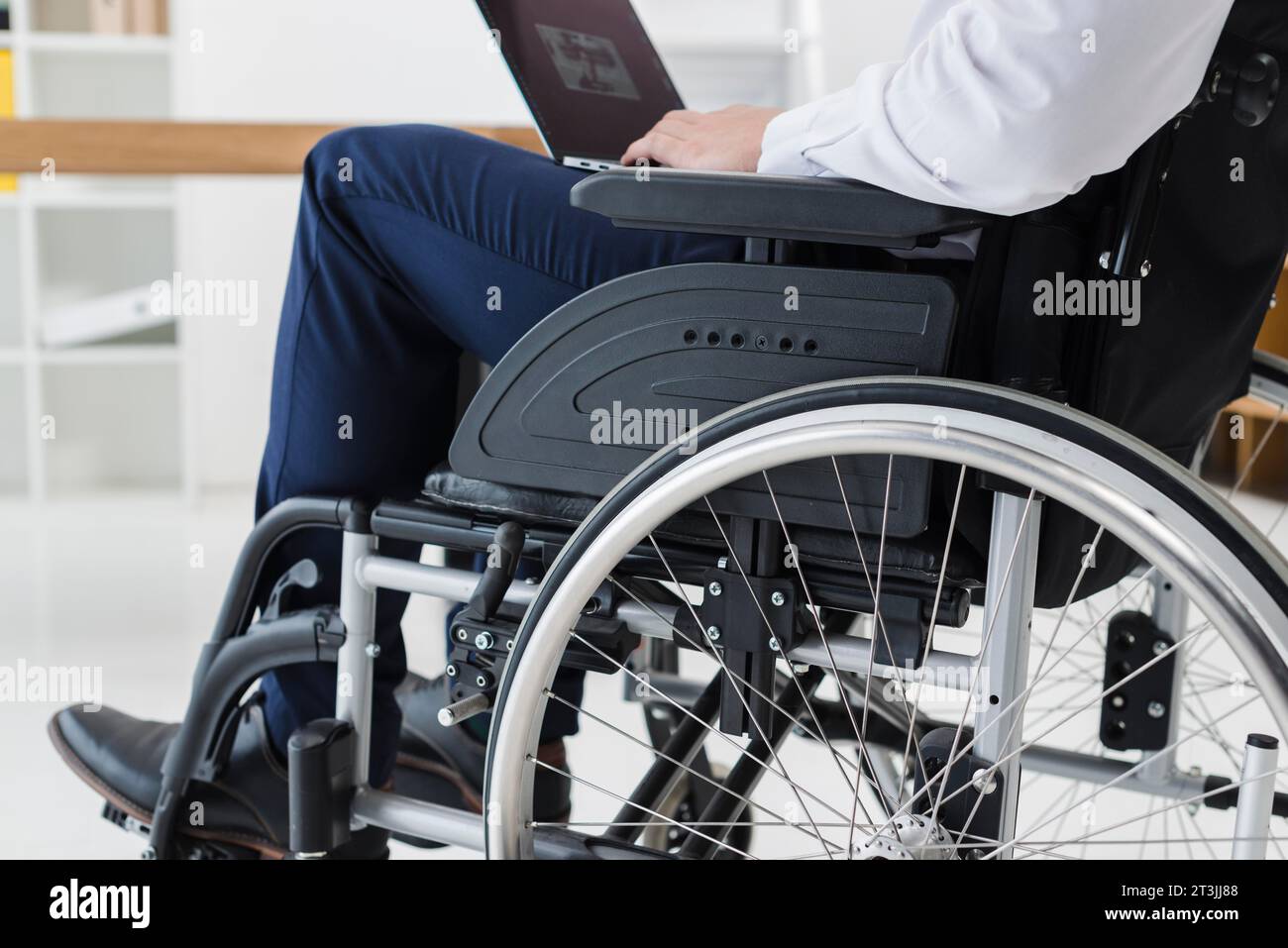 Businessman in wheelchair using computer hi-res stock photography and ...