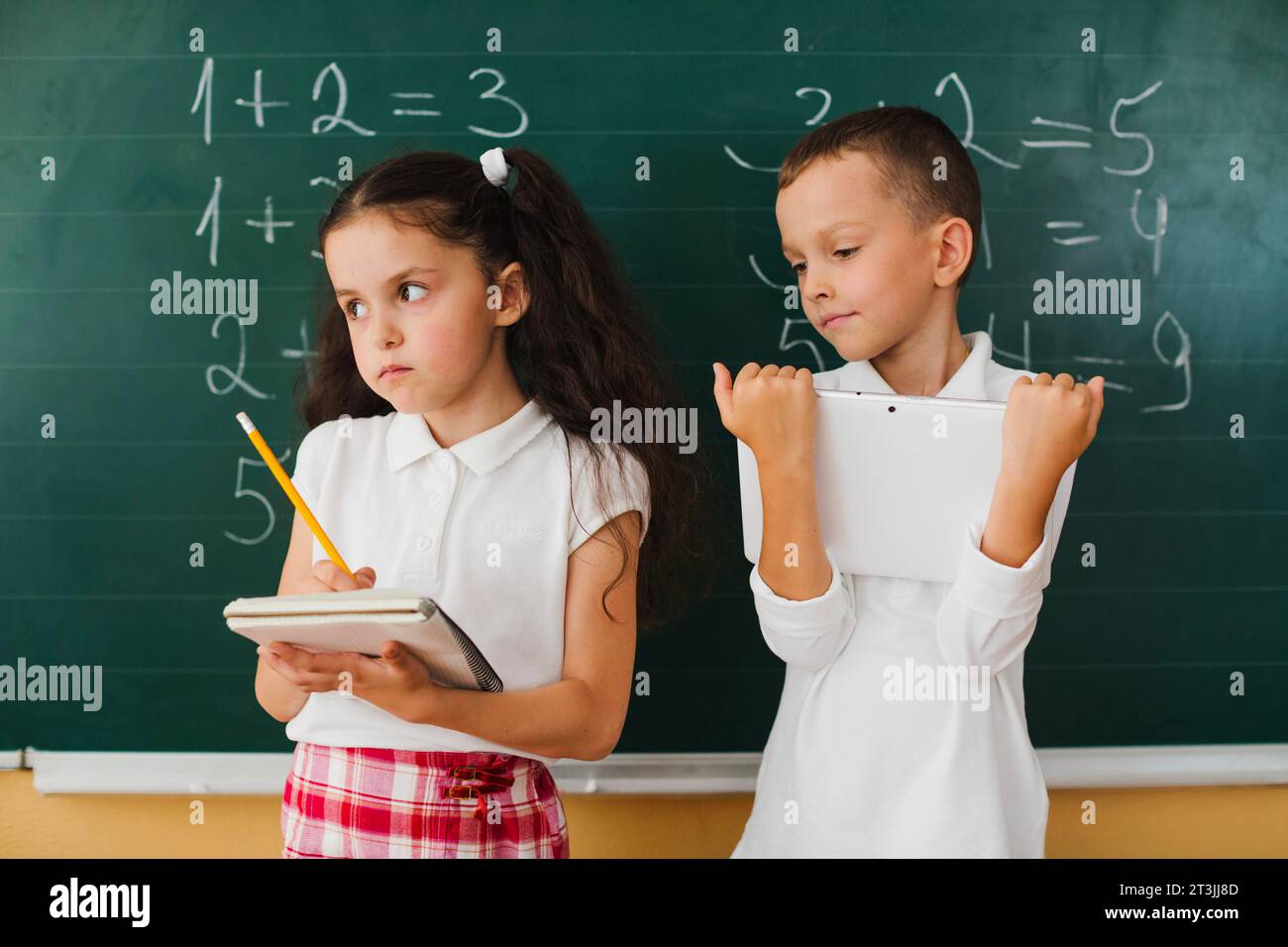 Classmates blackboard math lesson Stock Photo - Alamy