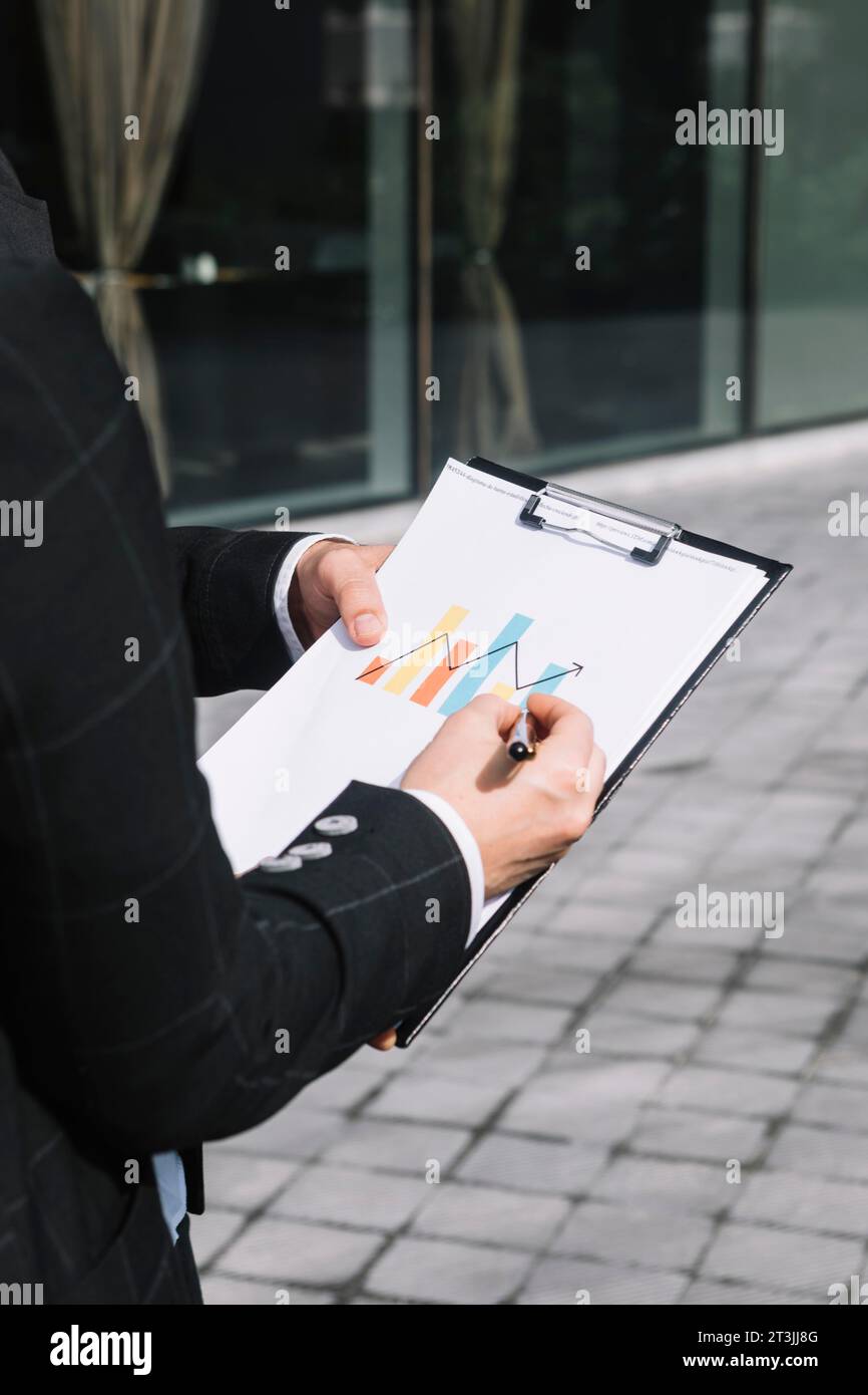 Close up business person s hand drawing increasing arrow graph ...