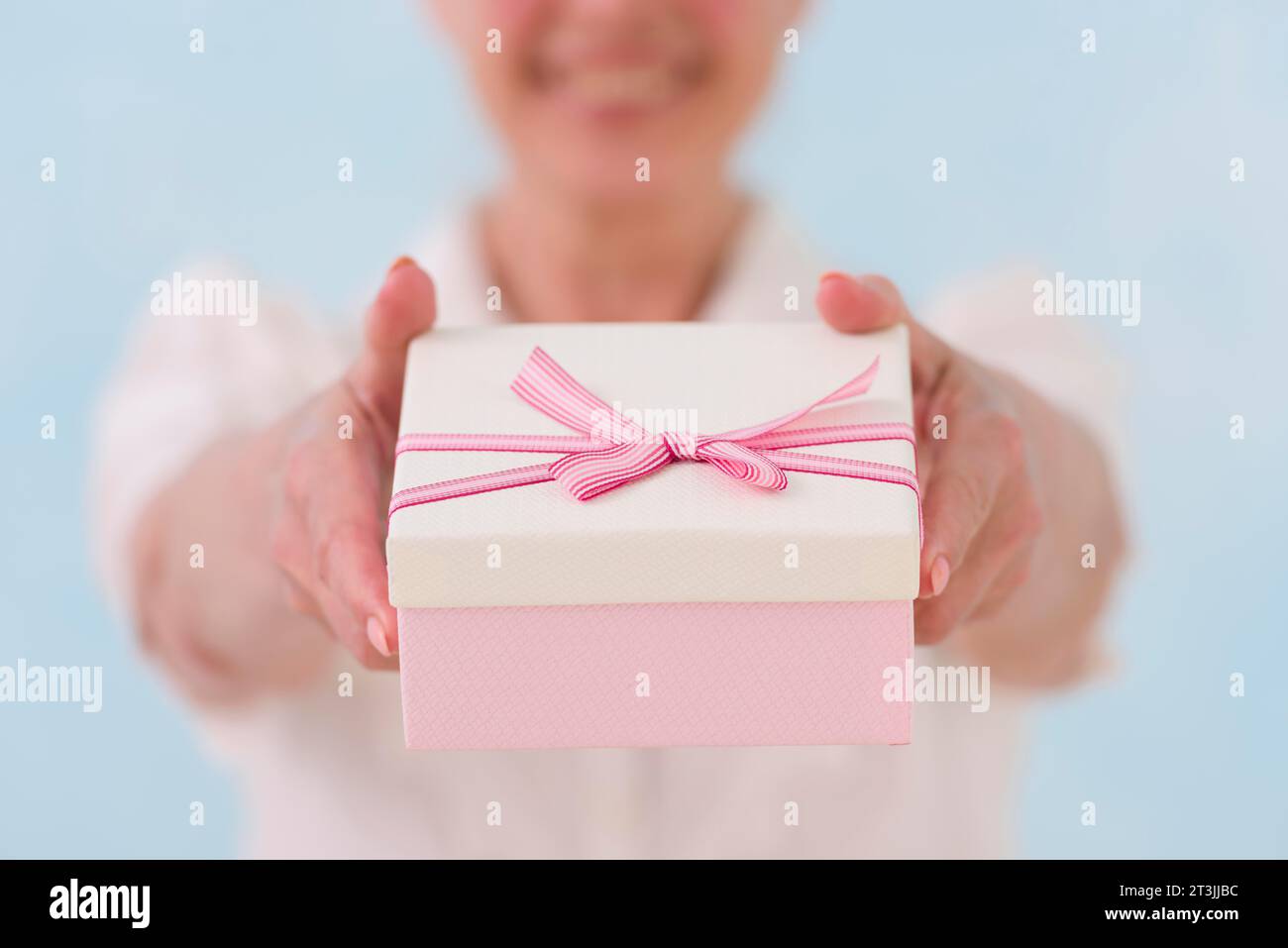 Close up woman s hand giving gift box Stock Photo - Alamy