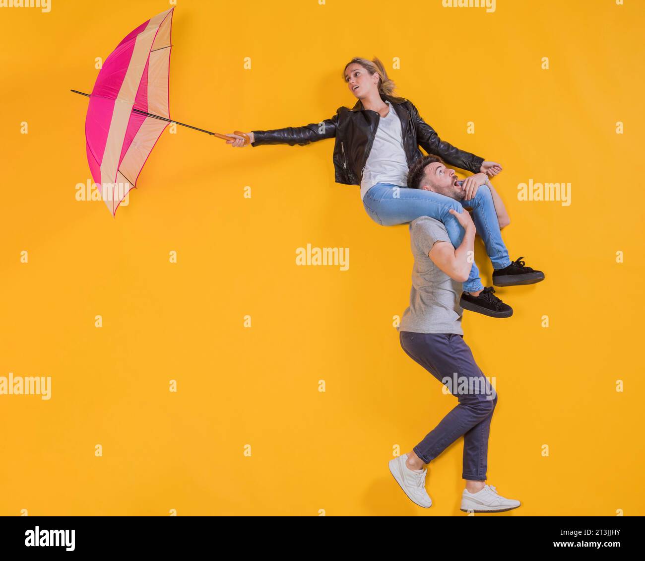 Couple floating with umbrella Stock Photo - Alamy