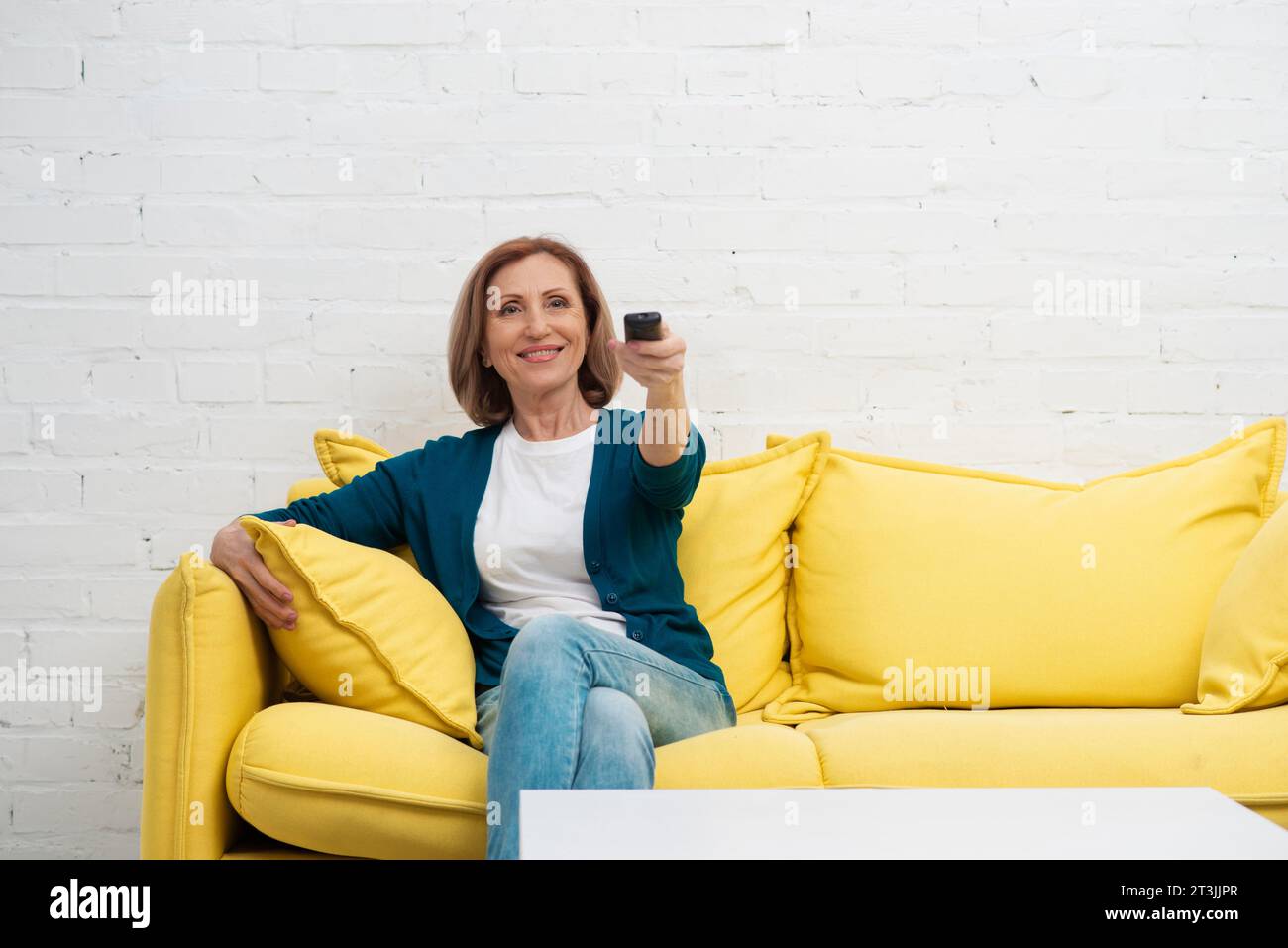Woman changing tv channels hi-res stock photography and images - Alamy