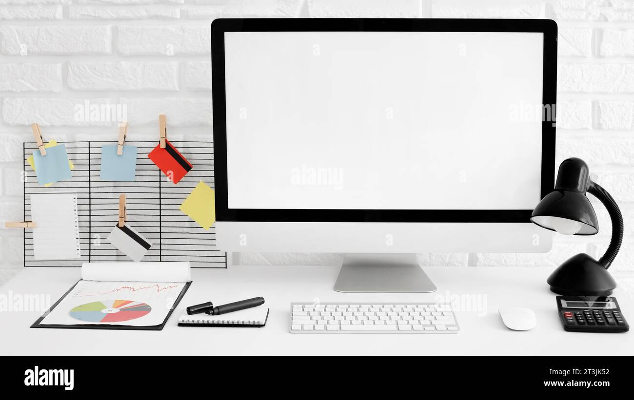 Front view office desk with computer lamp Stock Photo - Alamy