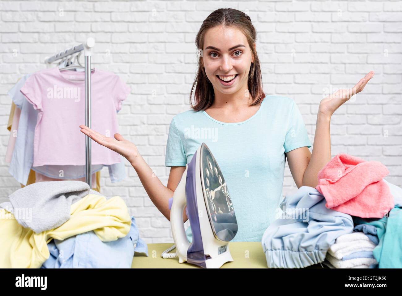Front view woman ready ironing clothes Stock Photo - Alamy