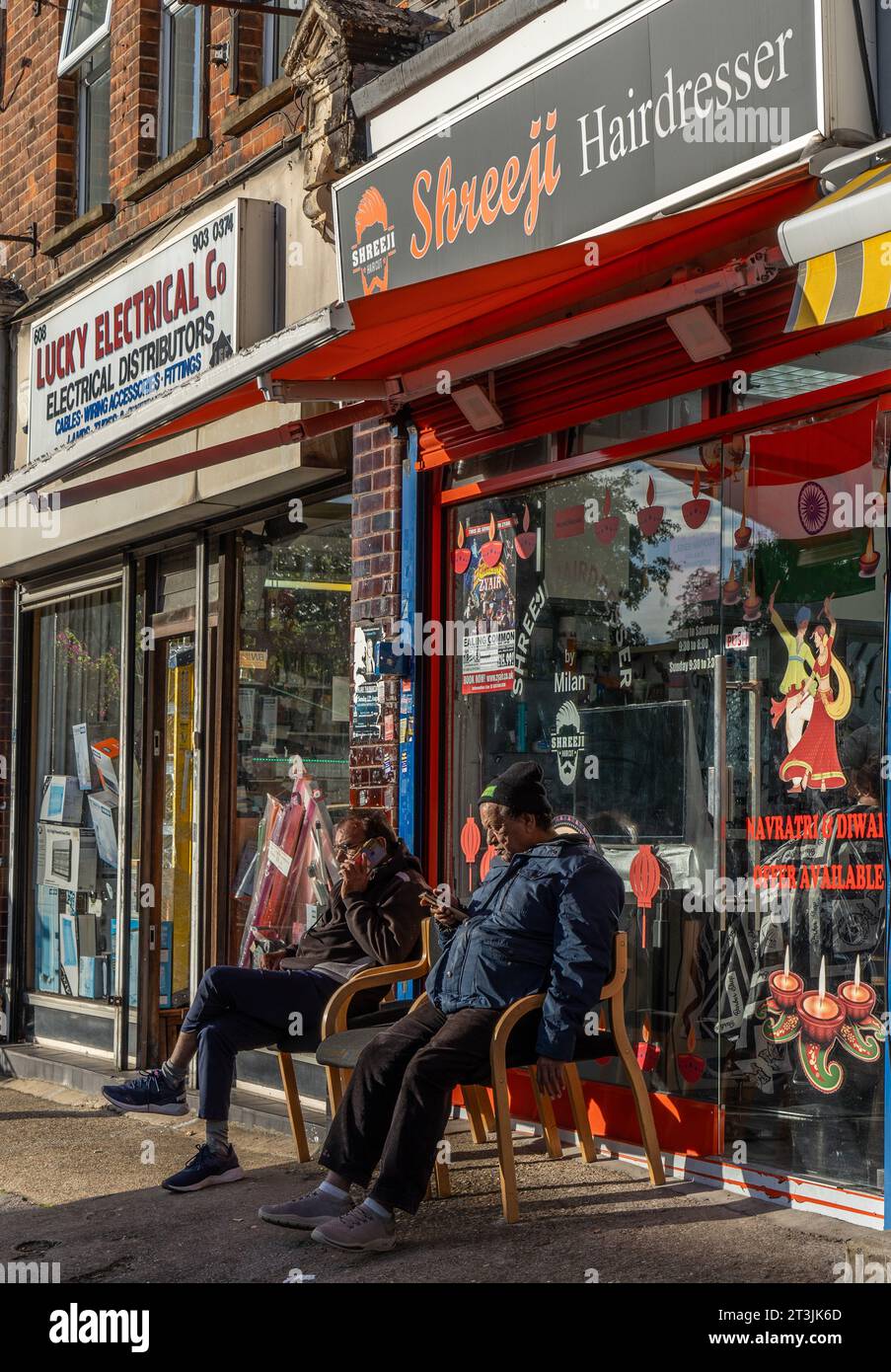 Indian shopkeepers sitting in the sun outside their shops in Wembley ...
