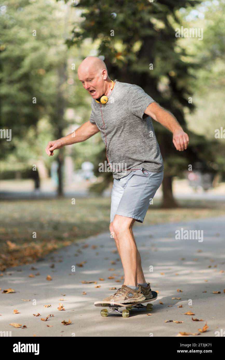 Full shot man with skateboard park Stock Photo - Alamy