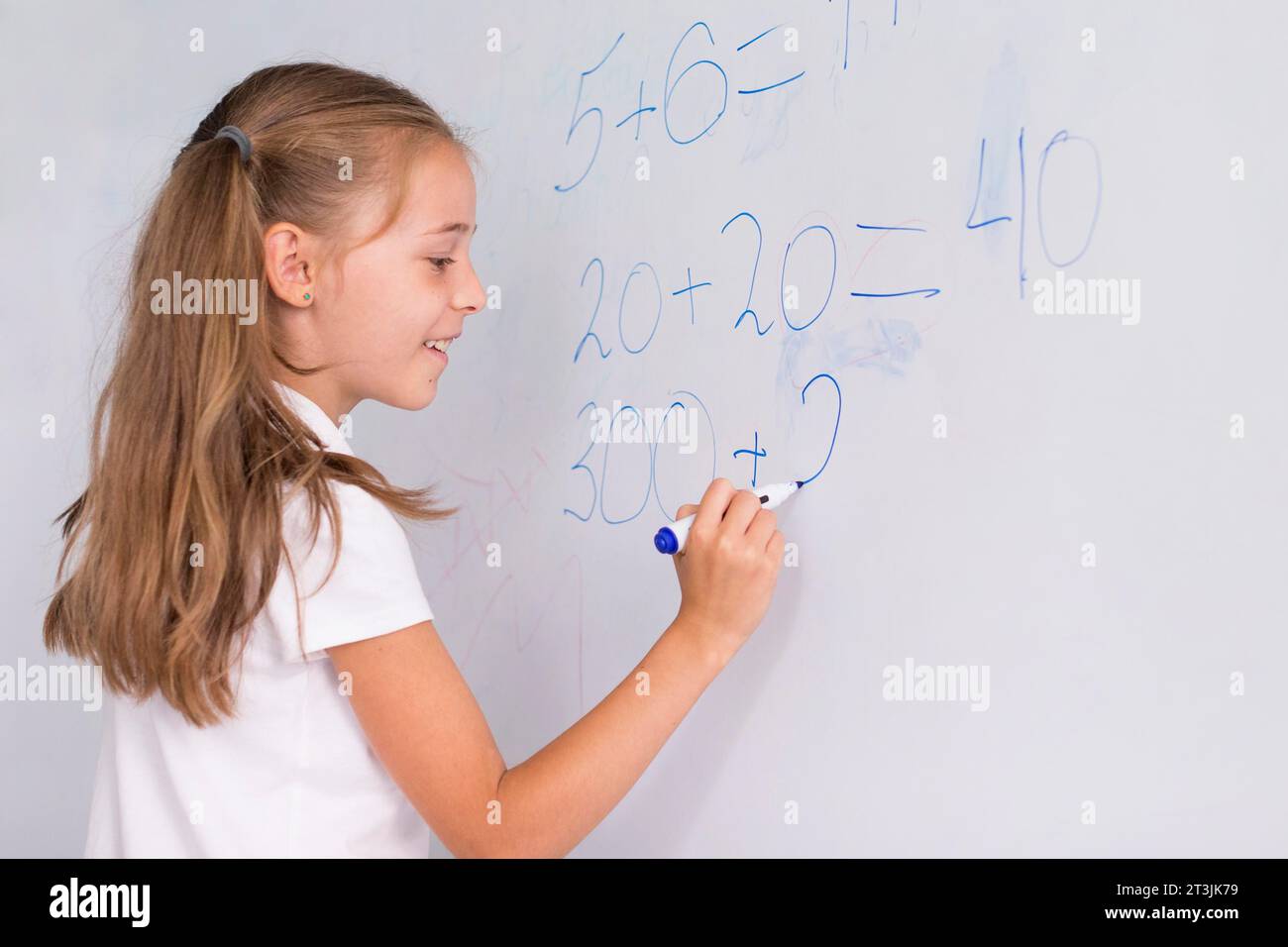 Girl doing math whiteboard Stock Photo - Alamy