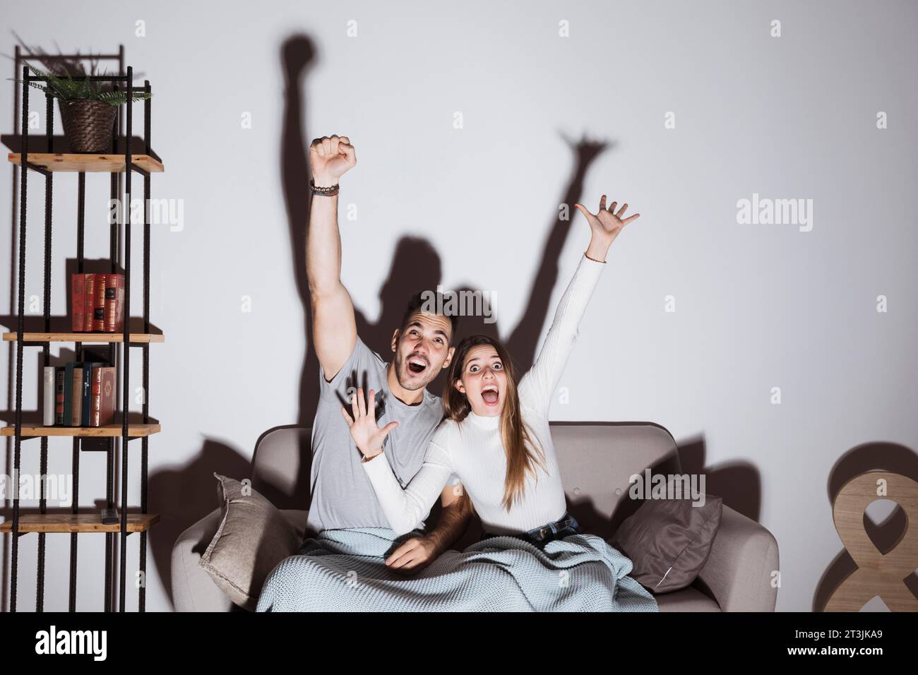 Happy crying lady guy watching tv sofa Stock Photo - Alamy