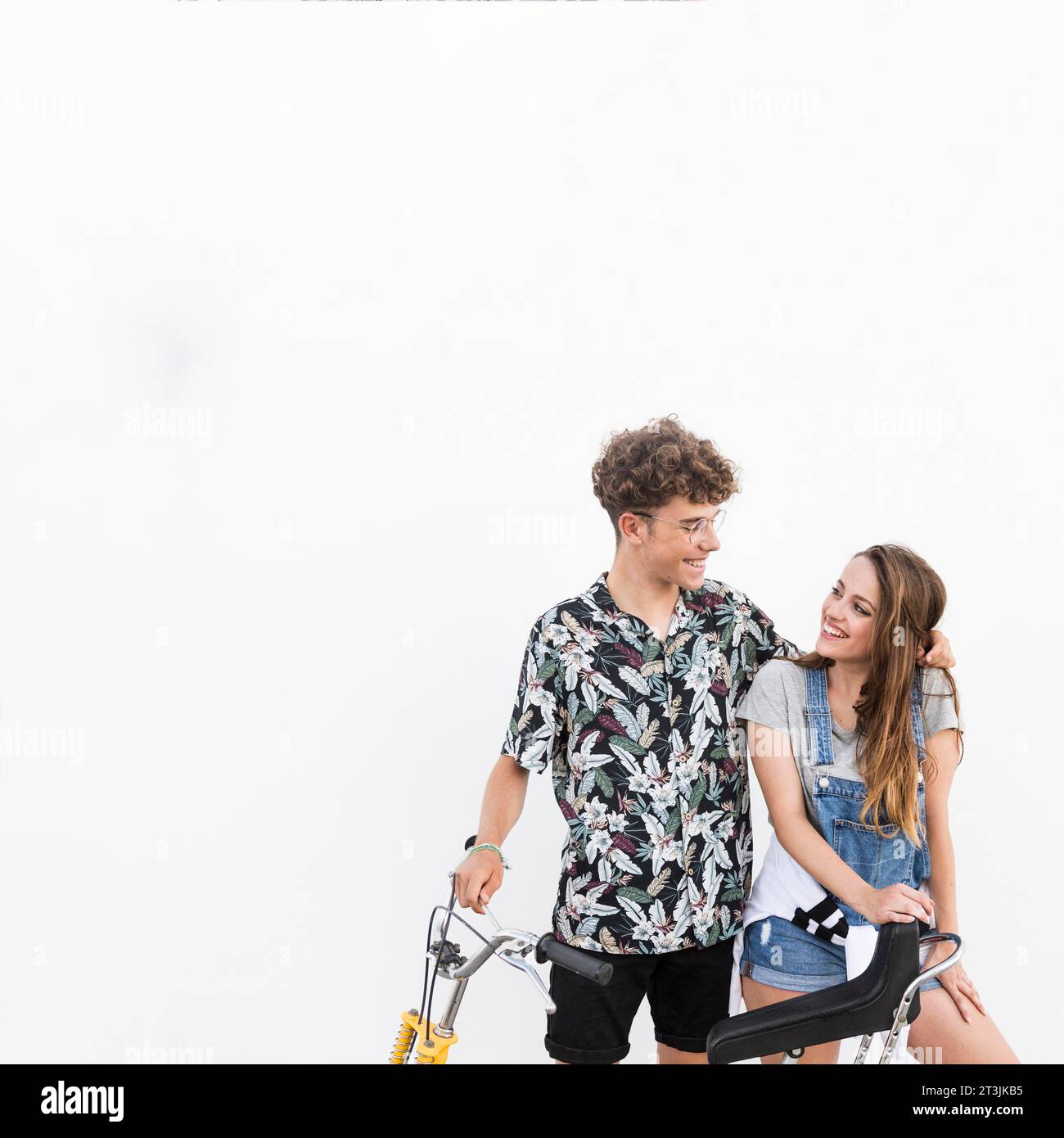 Happy couple with bicycle looking each other white background Stock ...