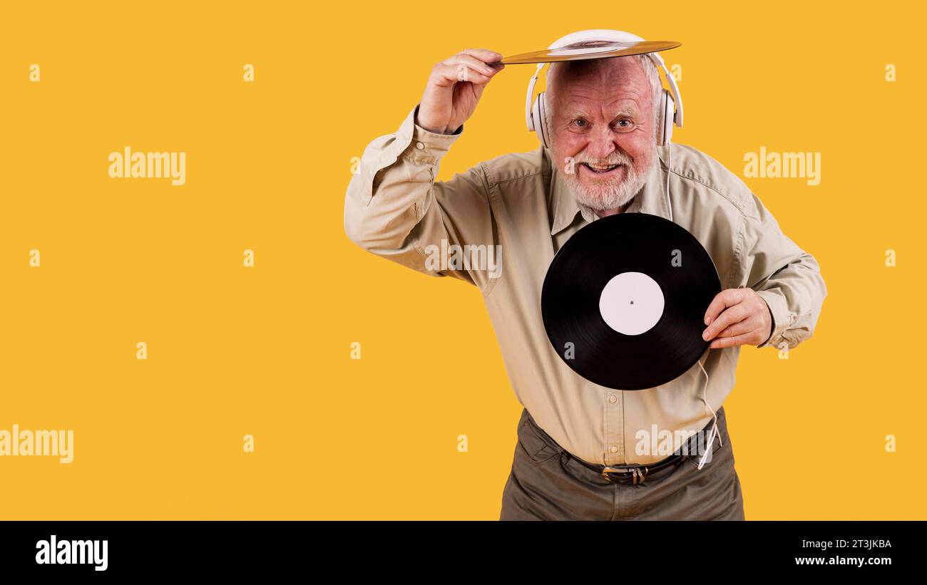 Happy senior playing with music records Stock Photo - Alamy