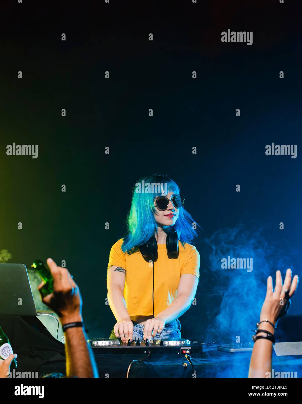 Low angle female dj setting party mood Stock Photo - Alamy