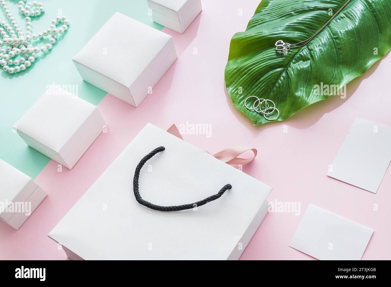 Jewelry with white boxes leaf paper backdrop Stock Photo - Alamy