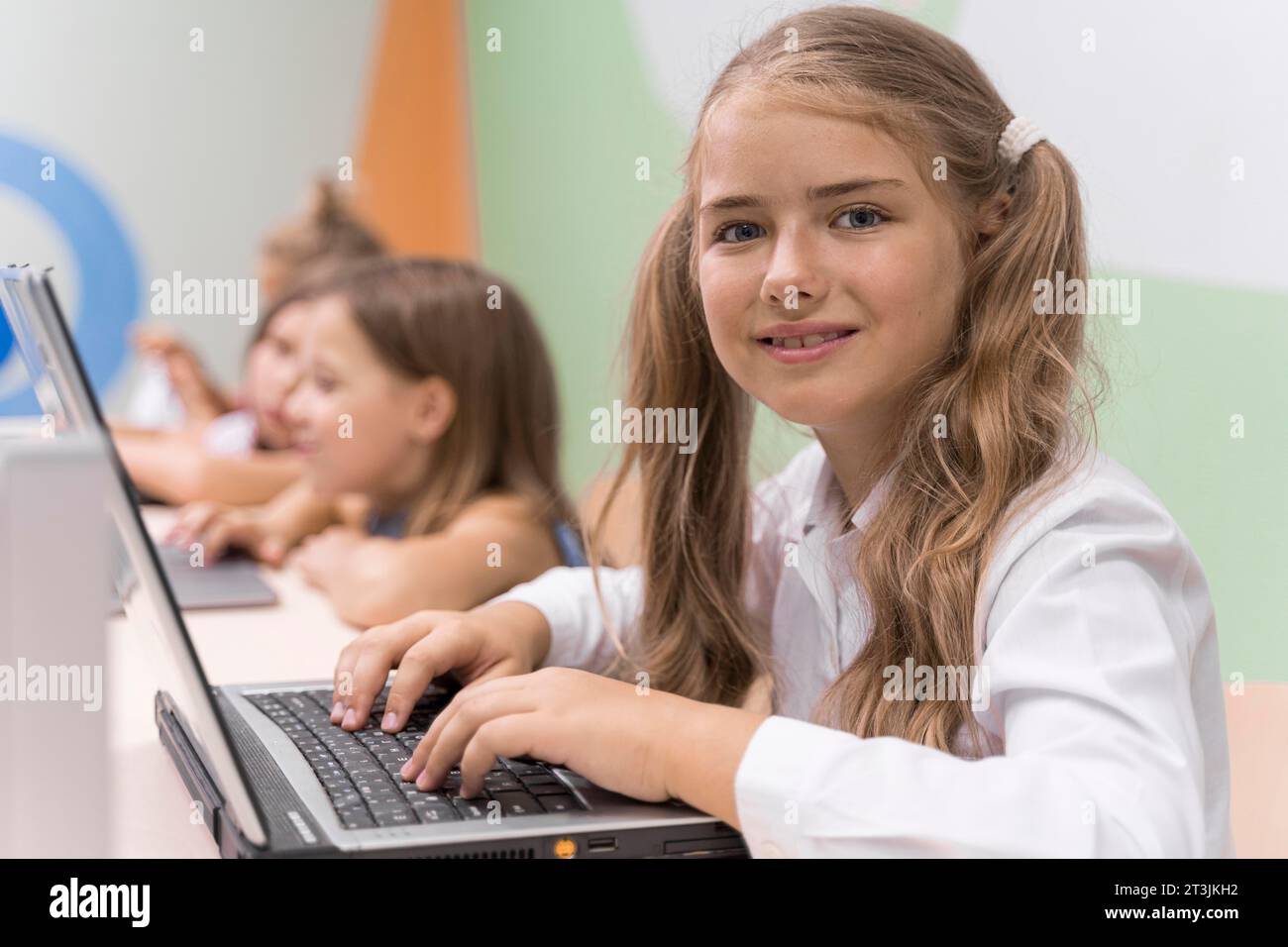 Kids using laptop school Stock Photo - Alamy