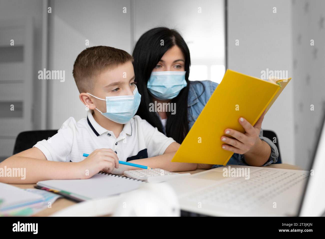 Medium shot woman kid with mask Stock Photo - Alamy