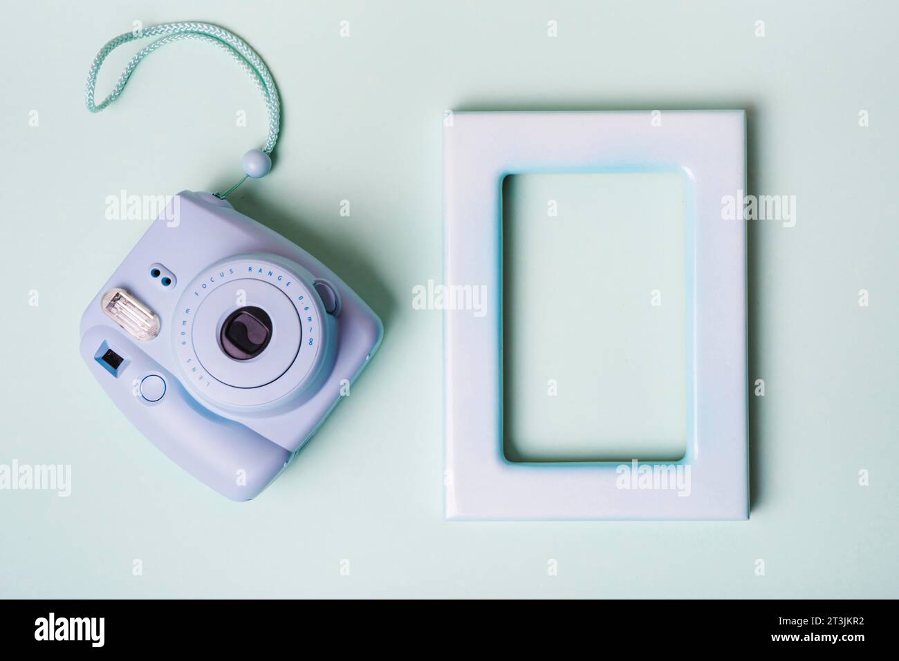 Mini instant camera empty border frame blue background Stock Photo - Alamy
