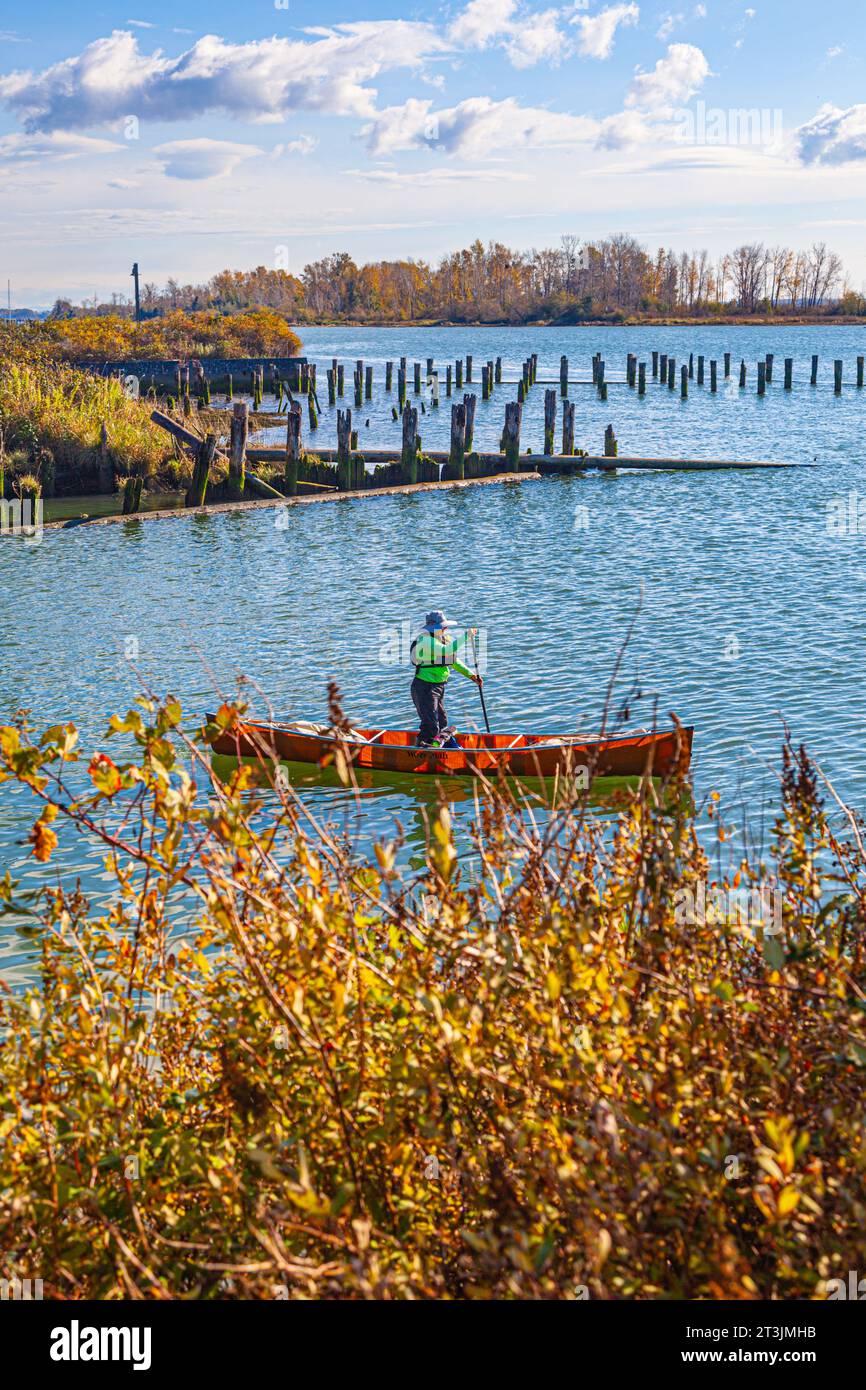 Lone paddler in a canoe on the Steveston waterfront in British Columbia ...