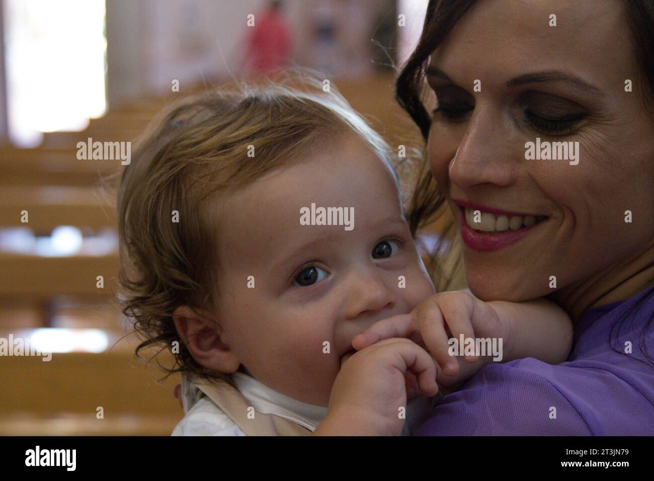 Image of a smiling young mother with her baby in her arms. Motherly ...