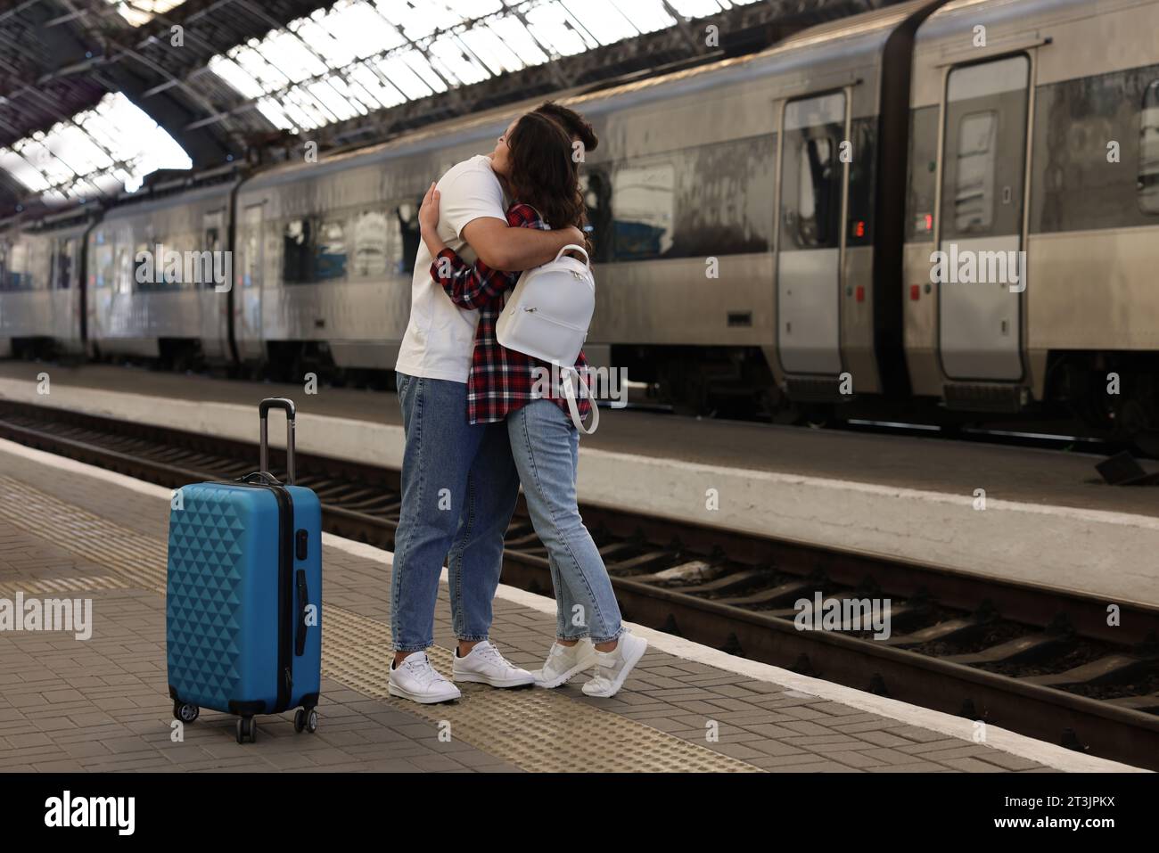 Long-distance relationship. Couple hugging on platform of railway station Stock Photo - Alamy