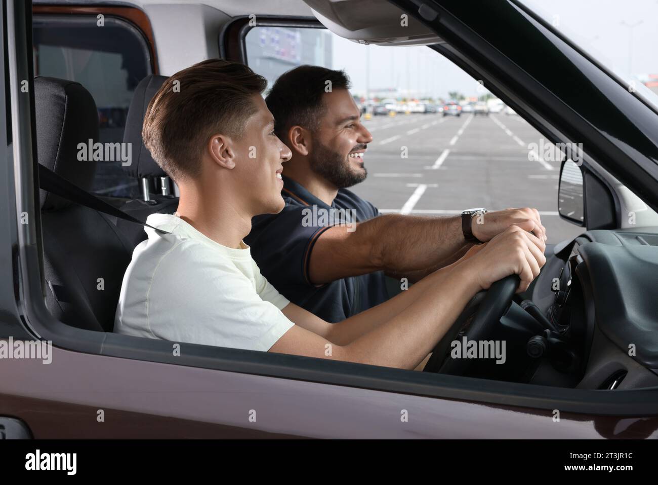 Driving school. Student during lesson with driving instructor in car at ...
