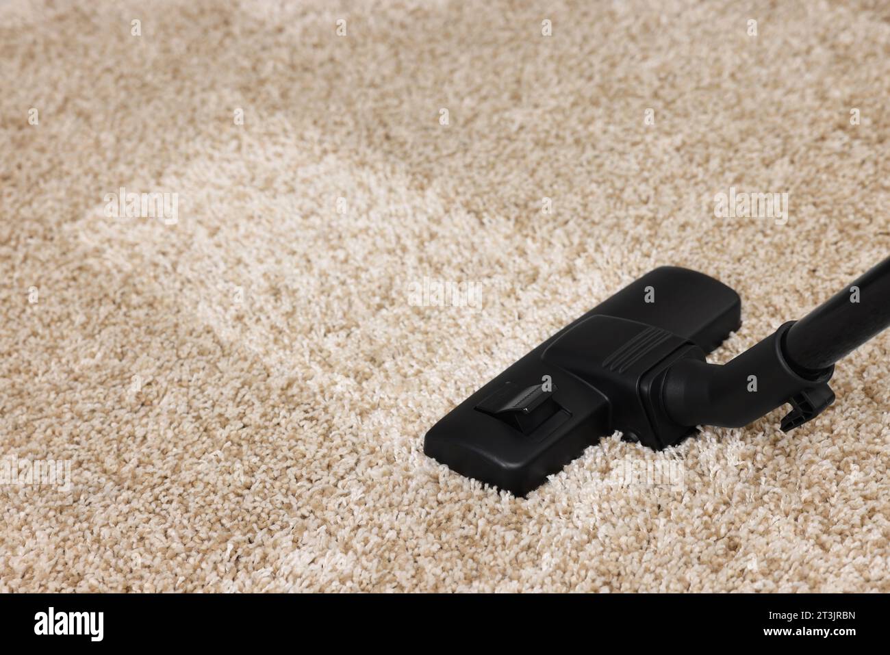 Hoovering carpet with vacuum cleaner, space for text Stock Photo - Alamy