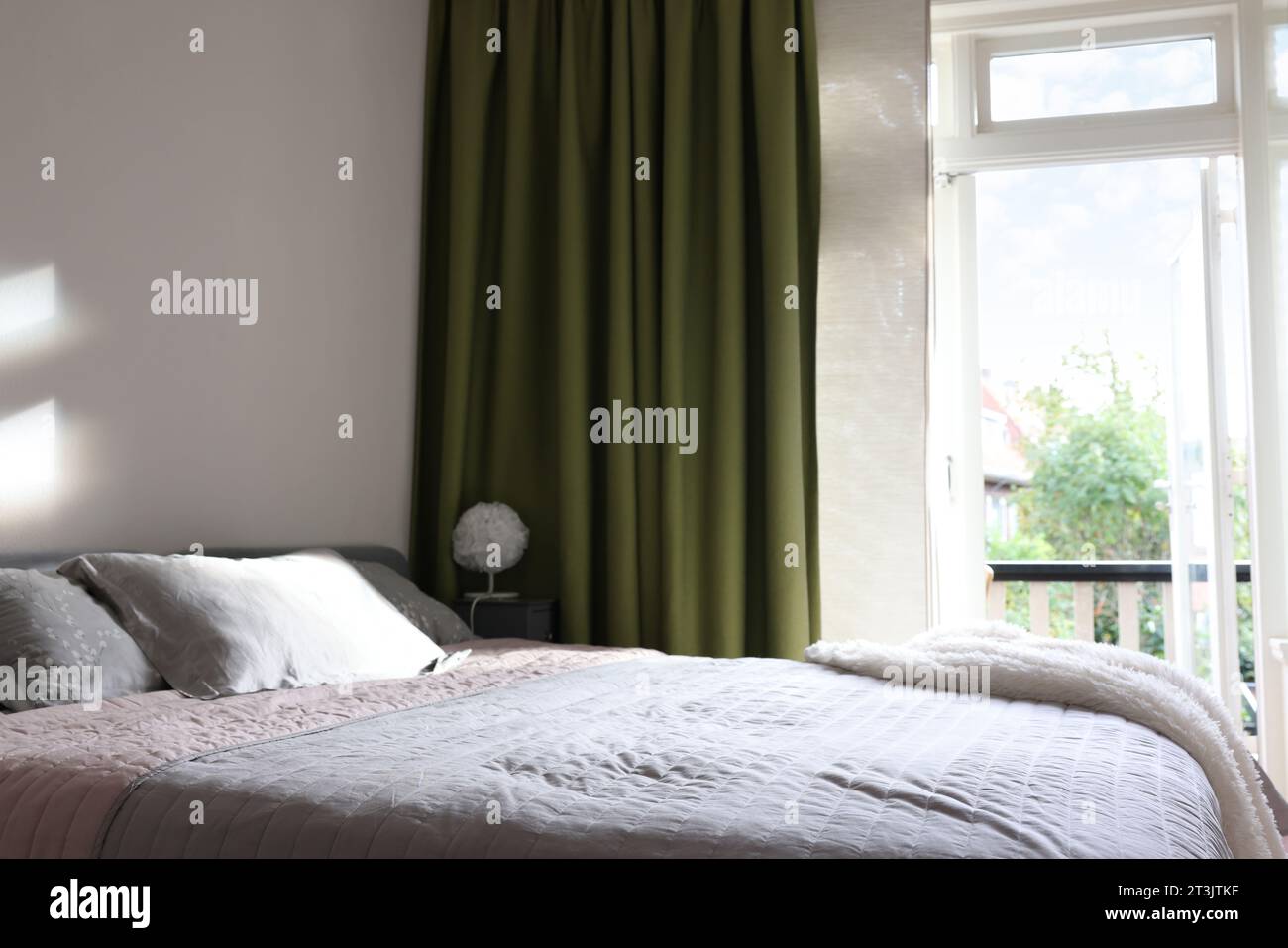 Stylish room interior with comfortable large bed Stock Photo - Alamy