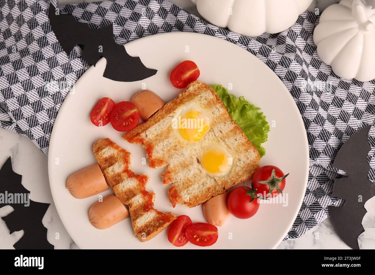Cute monster sandwich with cherry tomatoes, fried eggs and sausages on ...