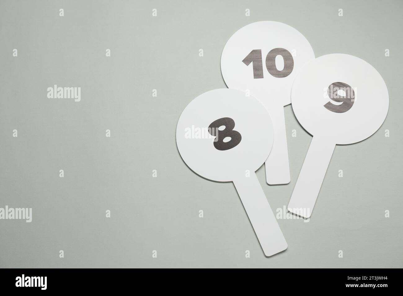 Auction paddles with numbers on light grey background, flat lay. Space ...