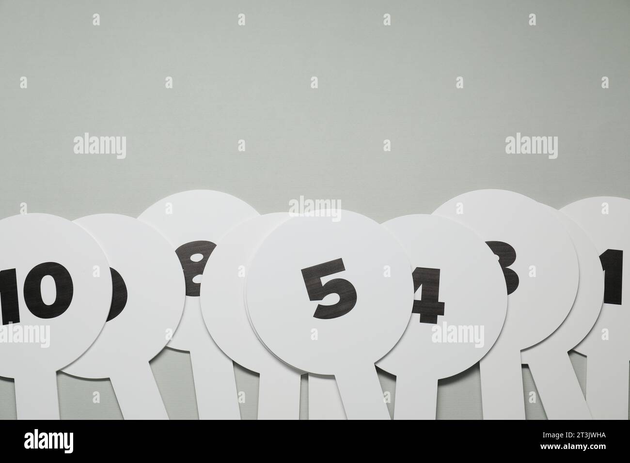 Auction paddles with numbers on light grey background, flat lay. Space ...