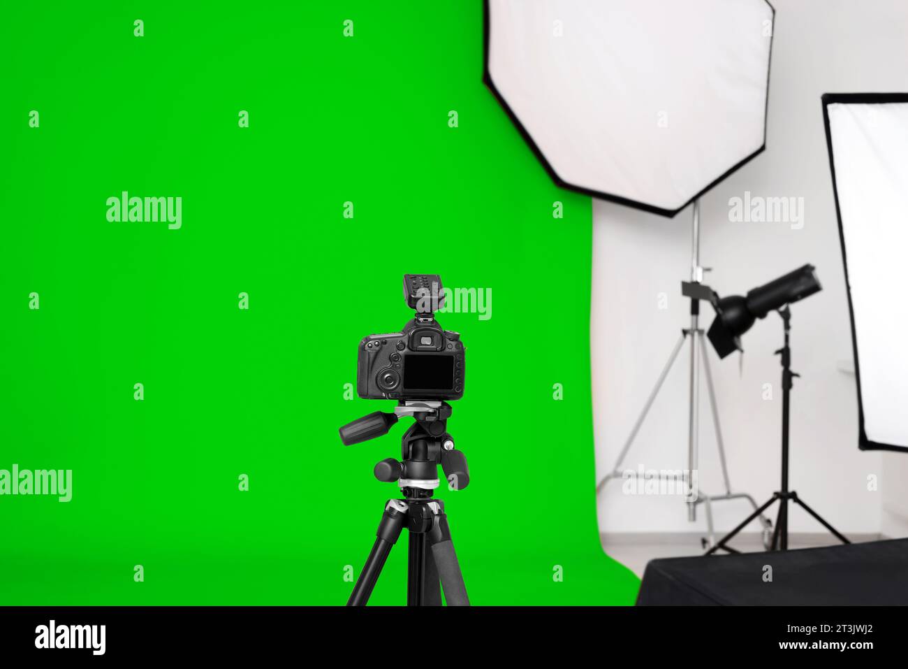 Chroma key compositing. Camera, green backdrop and equipment in studio ...