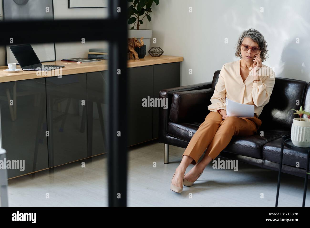 Mature woman making appointment phone hi-res stock photography and ...