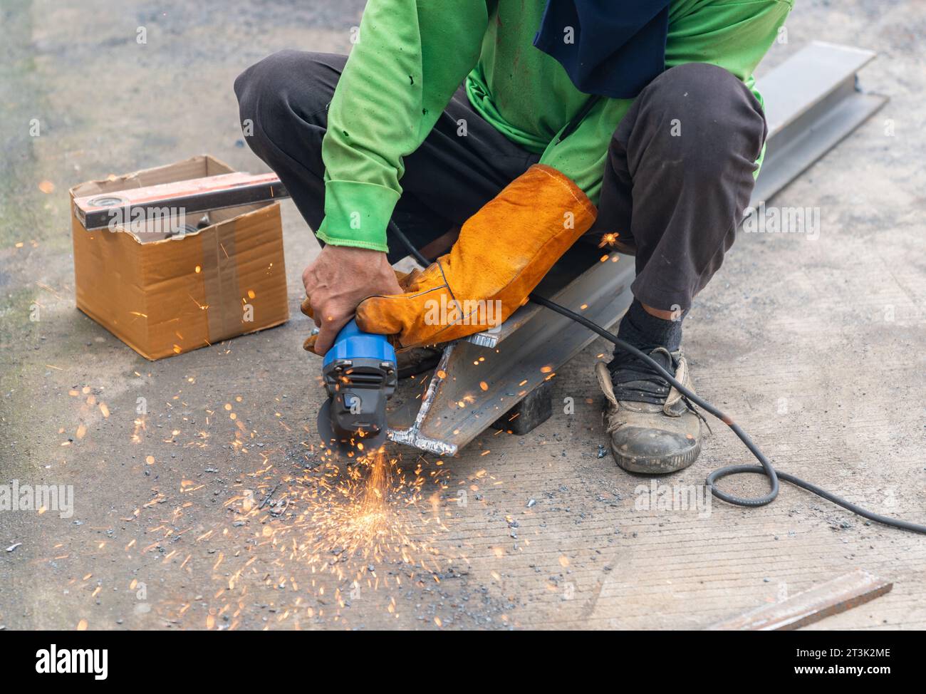 Worker is used Grinding Machine to grinding surface of Beam steel after ...