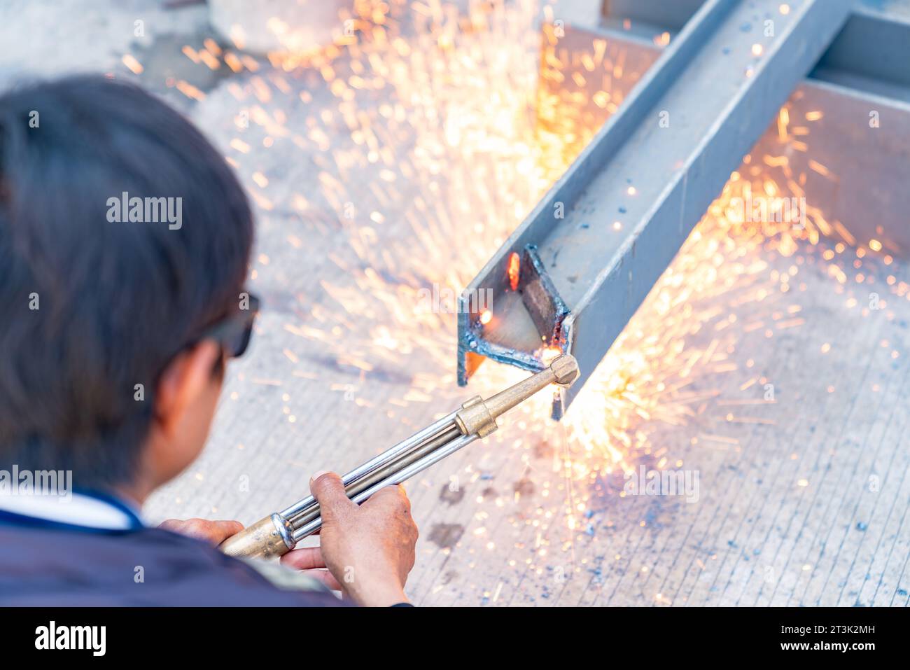 Worker cutting beam with acetylene torch in construction site Stock ...