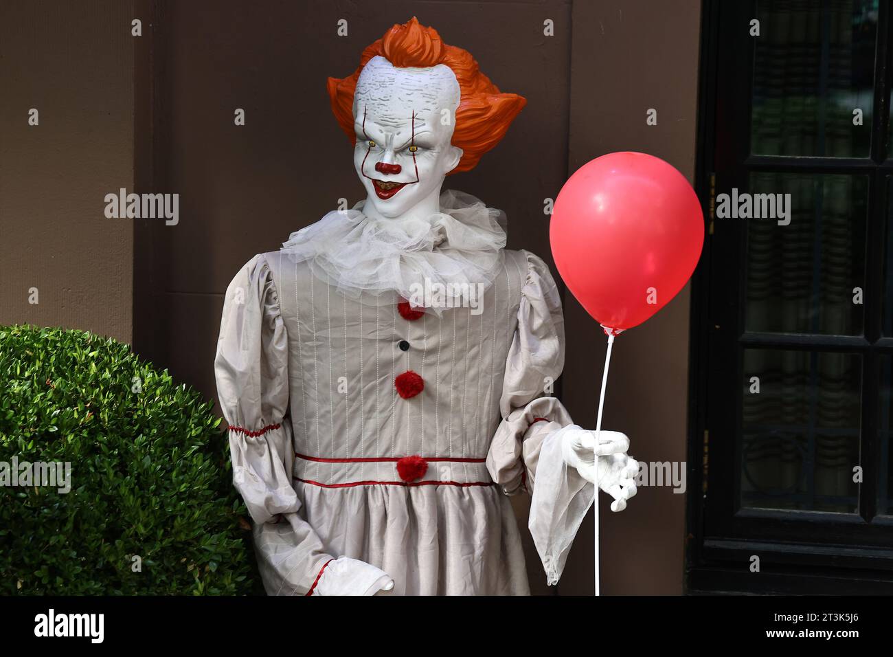 Creepy Halloween characters from terror films cover the doorway and the ...