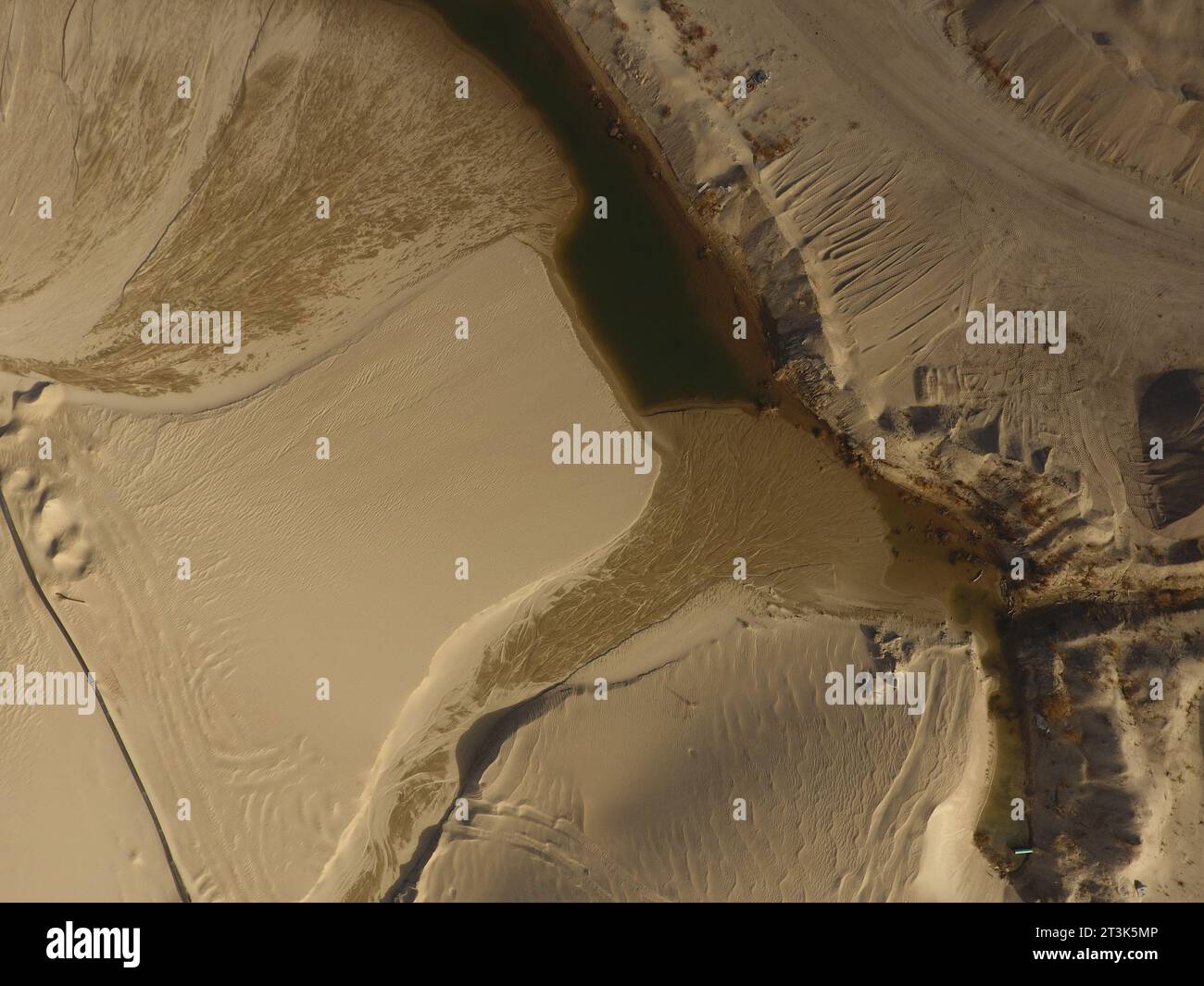Drone photo of a sand pit wet with puddles of water Stock Photo - Alamy