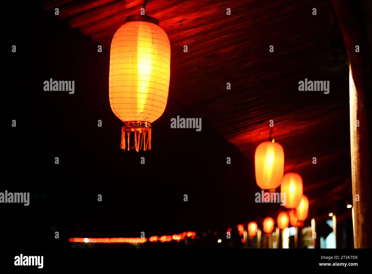 Night view photo of traditional Chinese style corridor, with traditional Chinese lanterns ...