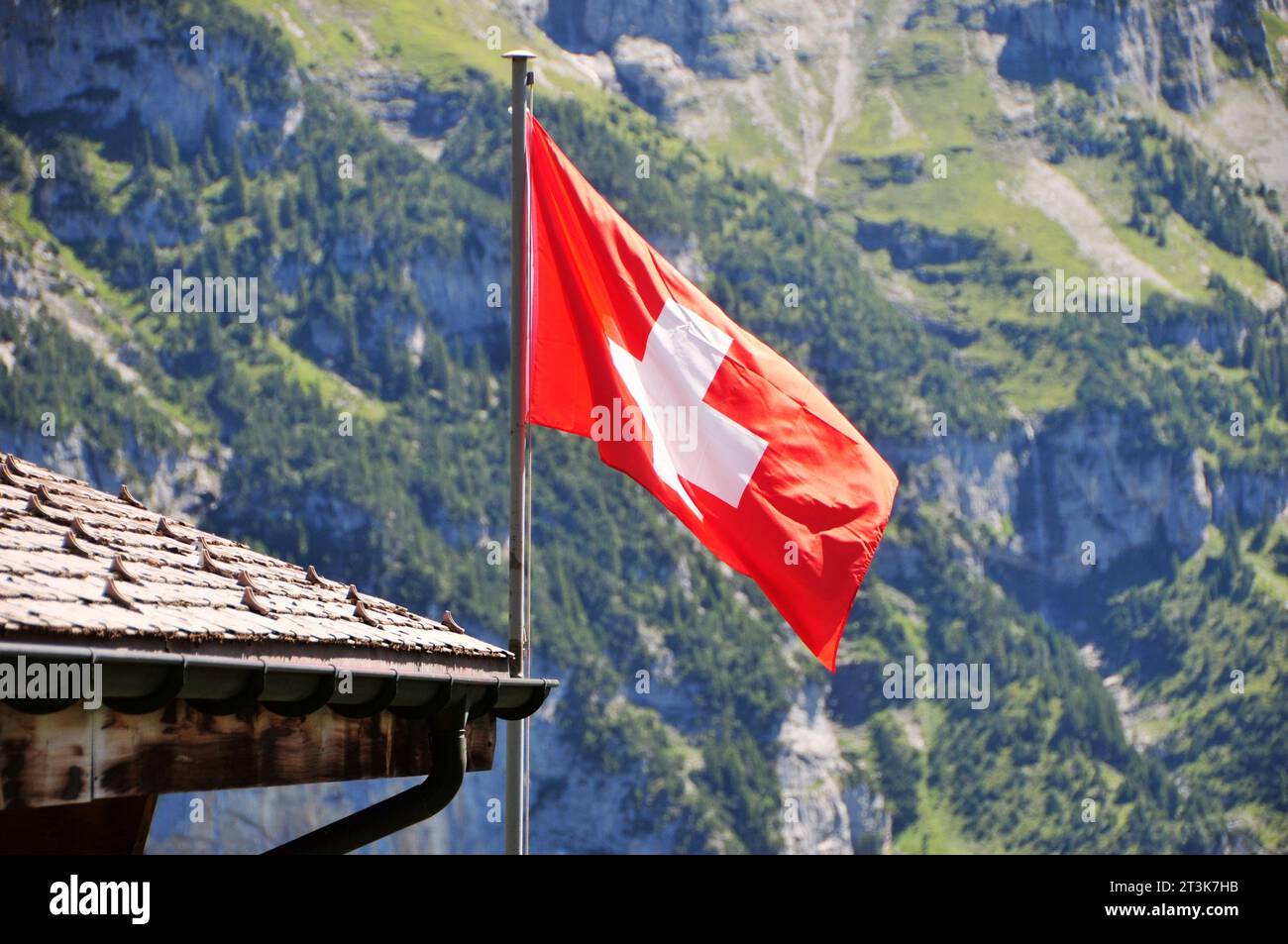Photo of Swiss flag flying on the roof Stock Photo - Alamy
