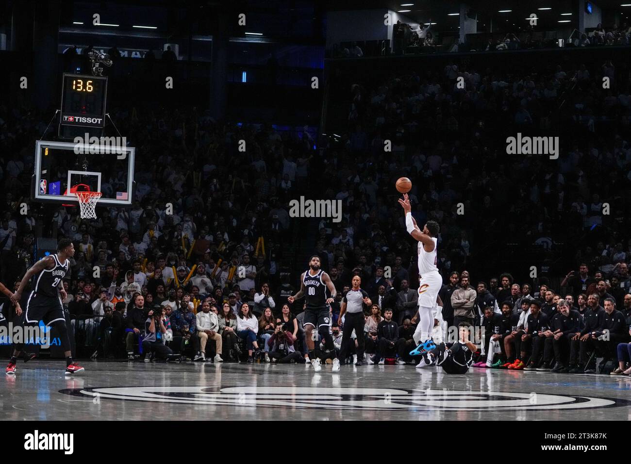Cleveland Cavaliers' Donovan Mitchell shoots a three-point shot as Brooklyn Nets' Royce O'Neale ...