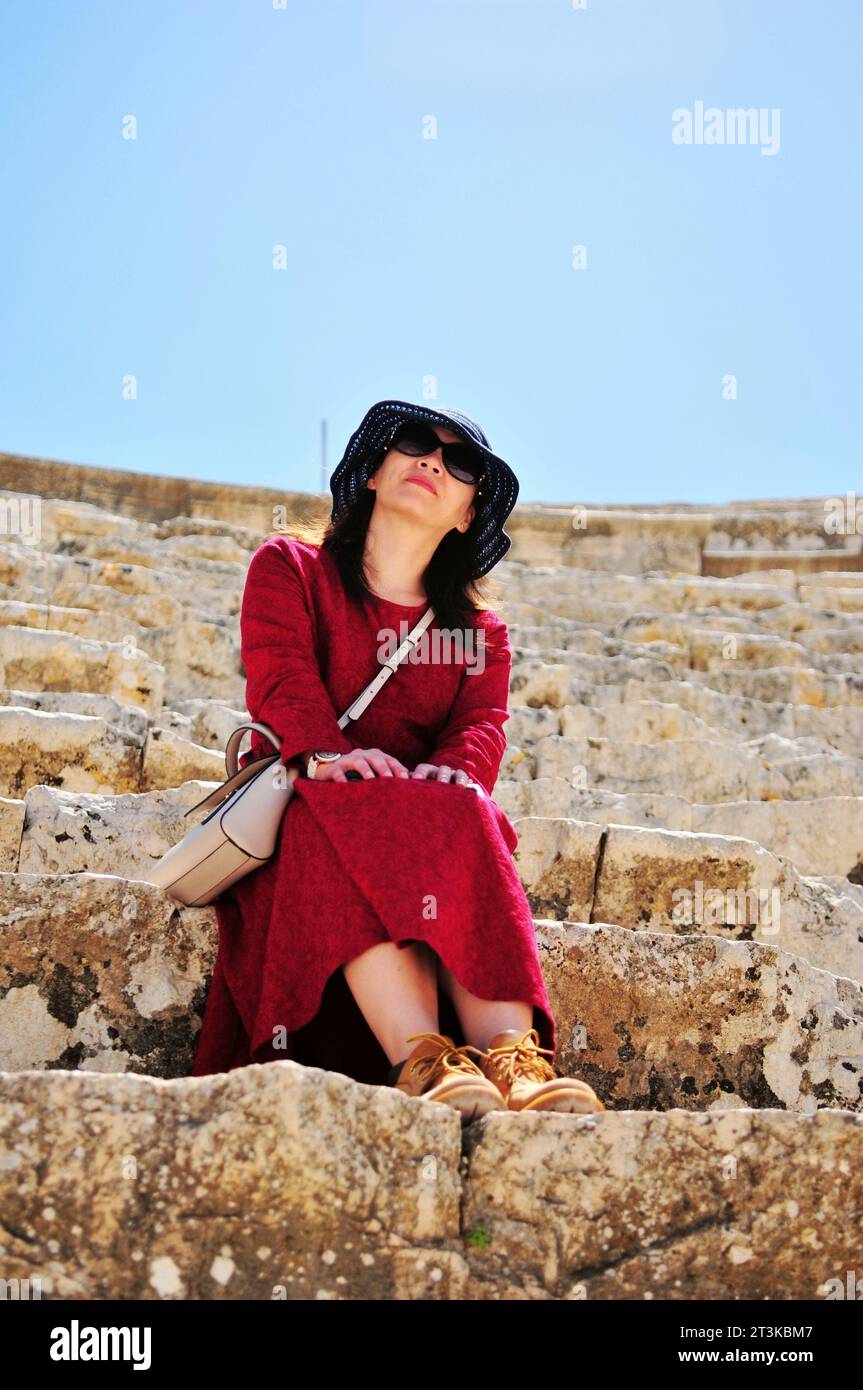 Photo of a woman sitting on stone steps Stock Photo - Alamy