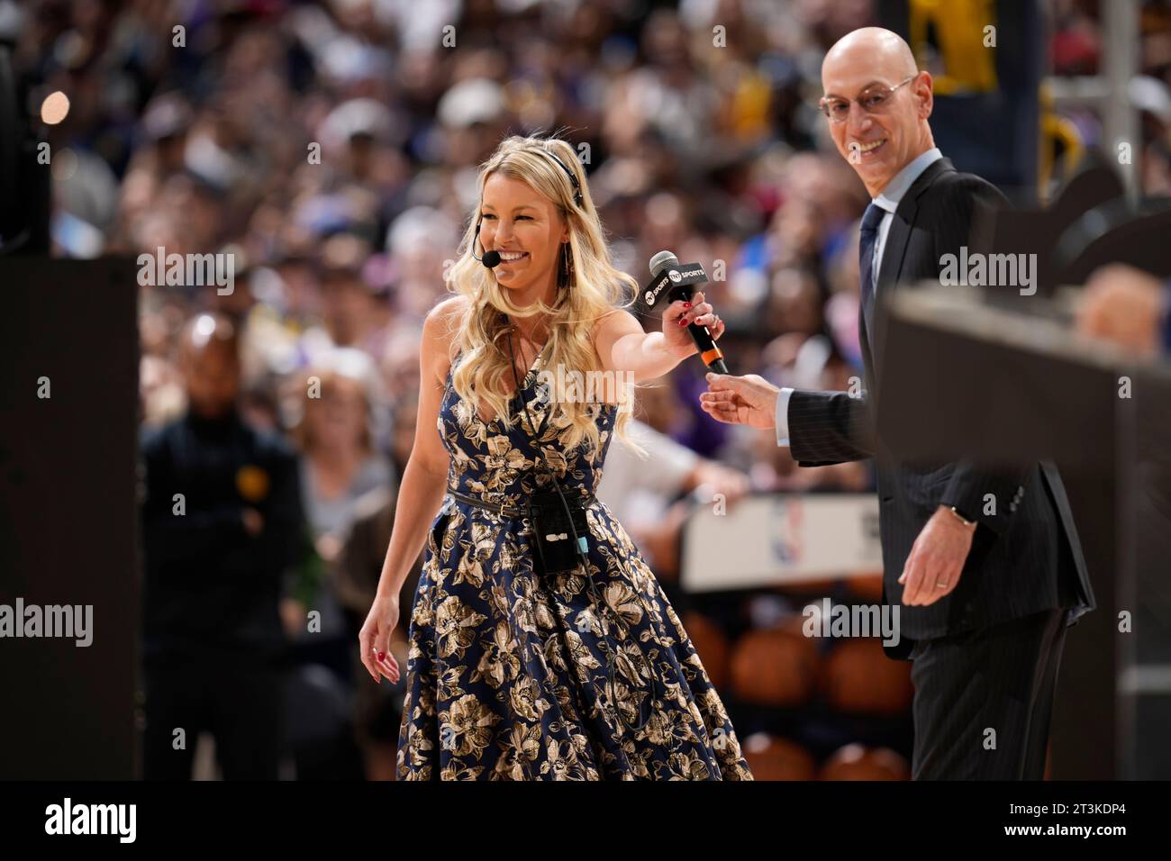 Denver Nuggets emcee Kerry Anne Keough, left, takes the microphone from ...