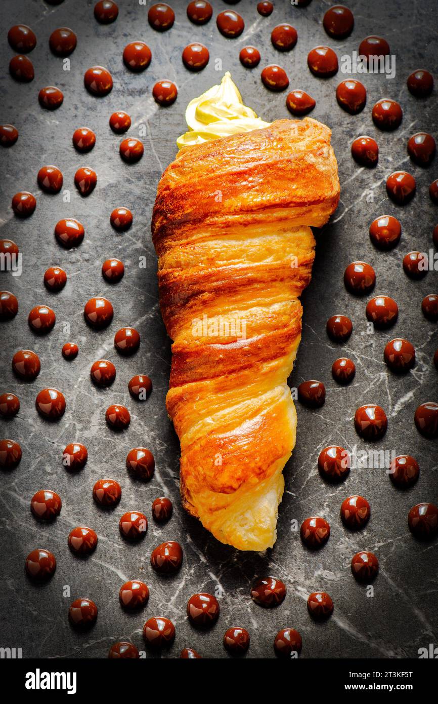 Delicious crispy, flaky, and buttery croissant cone, also know as a croissant horn, filled with ...